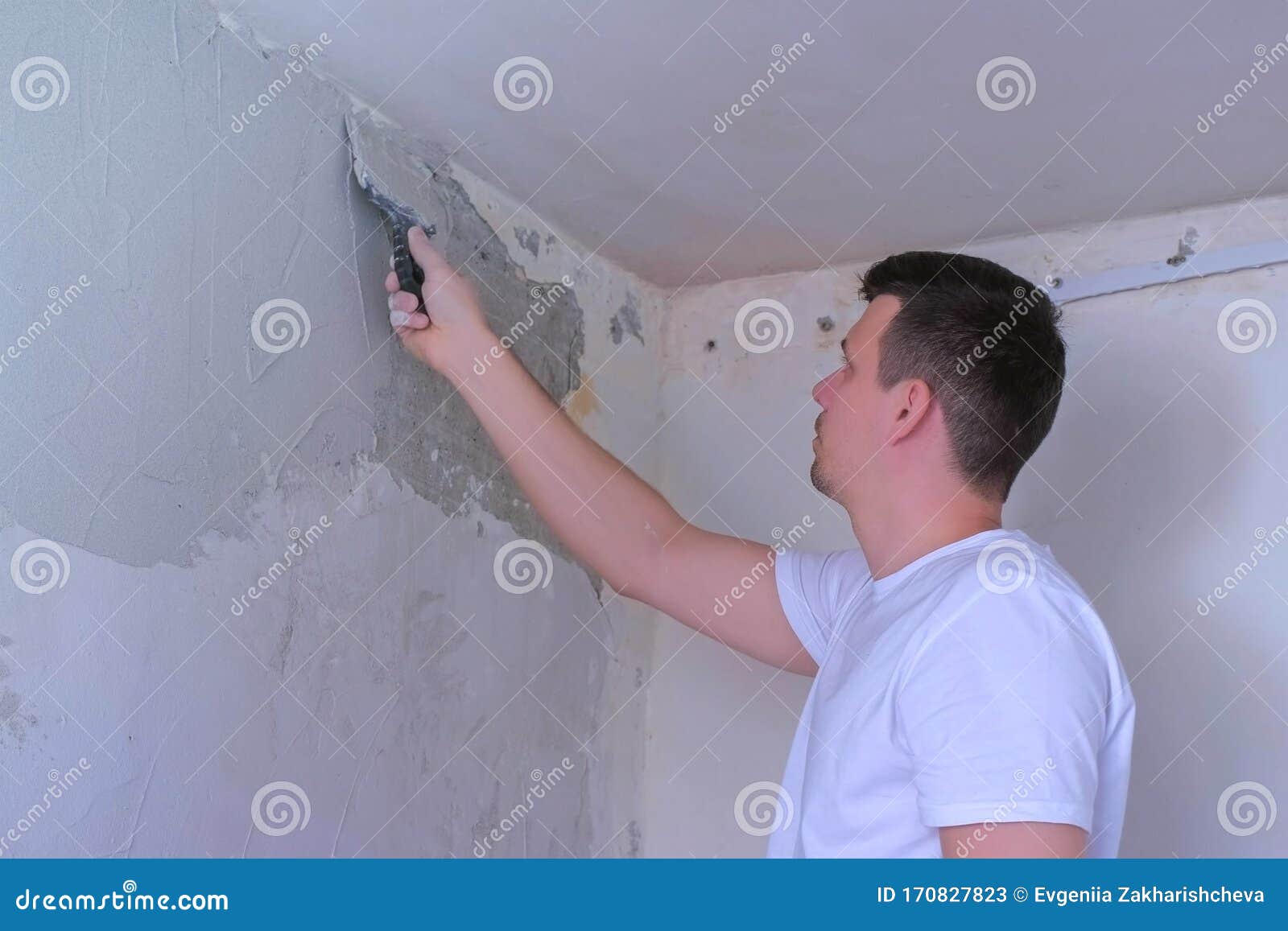Plasterer Man Spackling Wall with Putty Plaster Aligning Wall Using ...