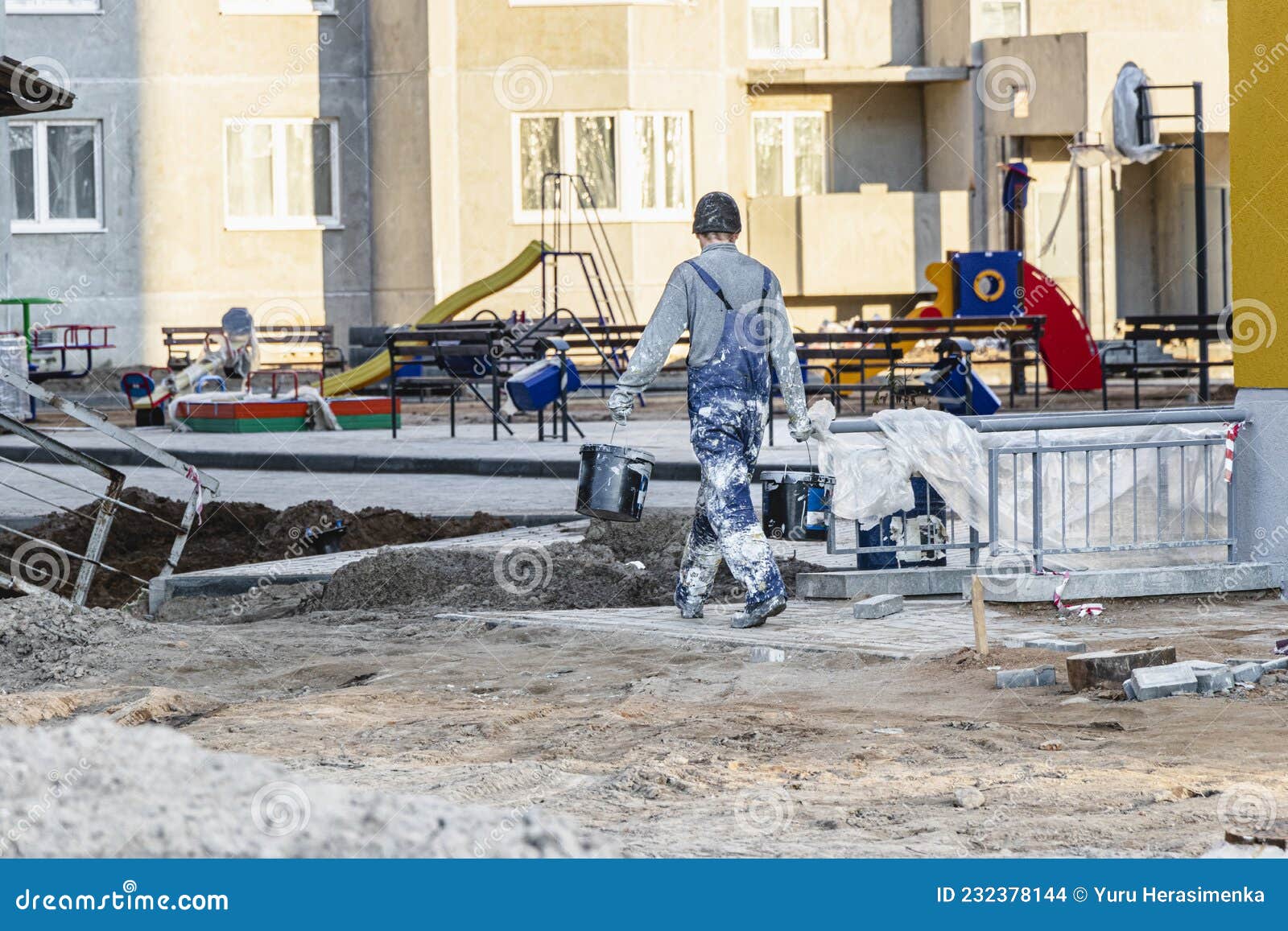 A Plasterer or Painter Worker in Dirty Work Clothes at a Construction ...
