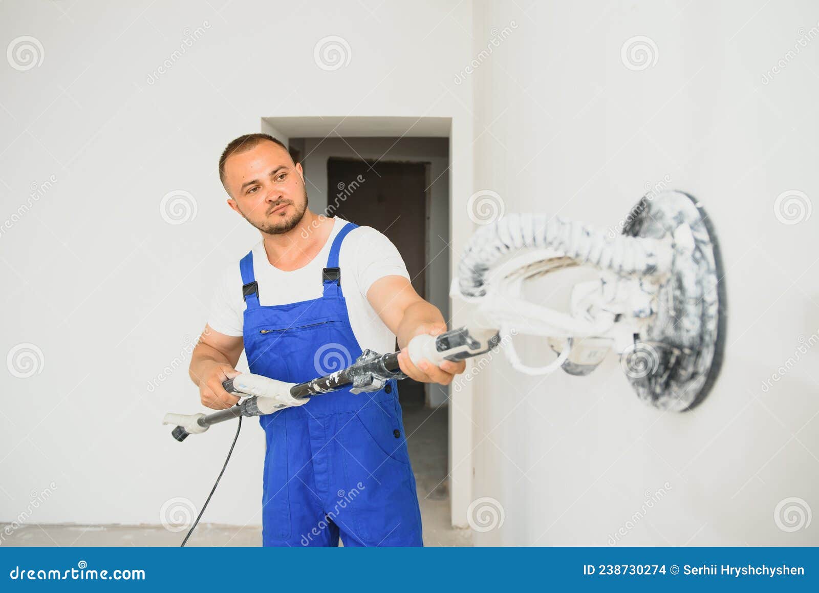 Plasterer Smoothes the Wall Surface with a Wall Grinder. Master Builder ...