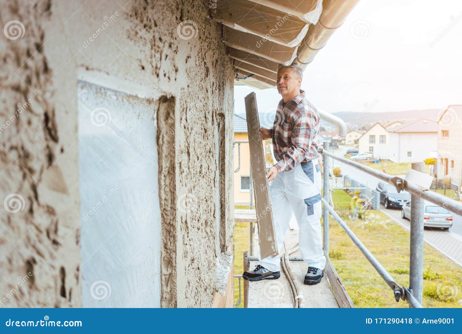 Plasterer Standing on Scaffolding at Construction Site Stock Photo ...
