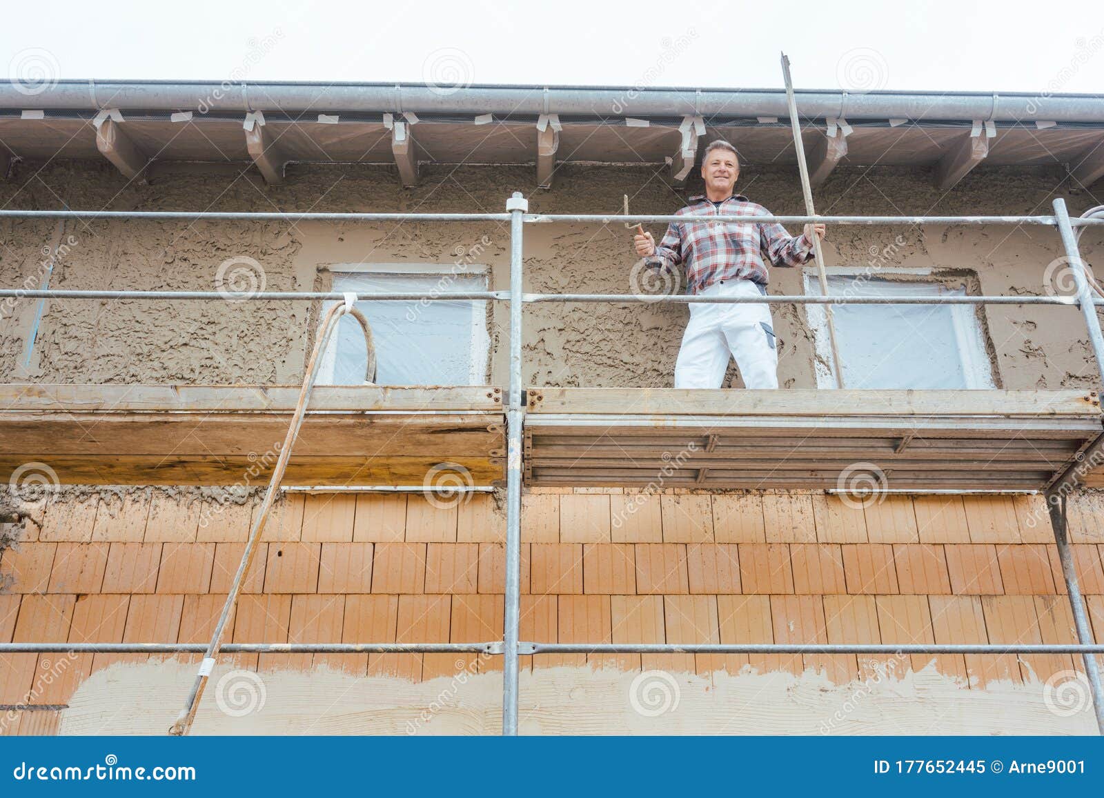 Plasterer Standing on Scaffolding at Construction Site Stock Image ...