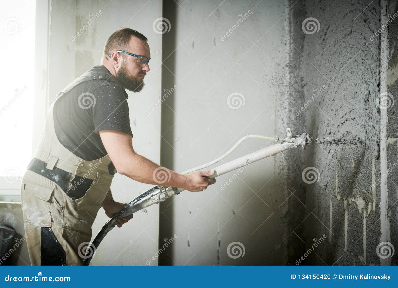 Plasterer Using Screeder Spraying Putty Plaster Mortar on Wall Stock ...
