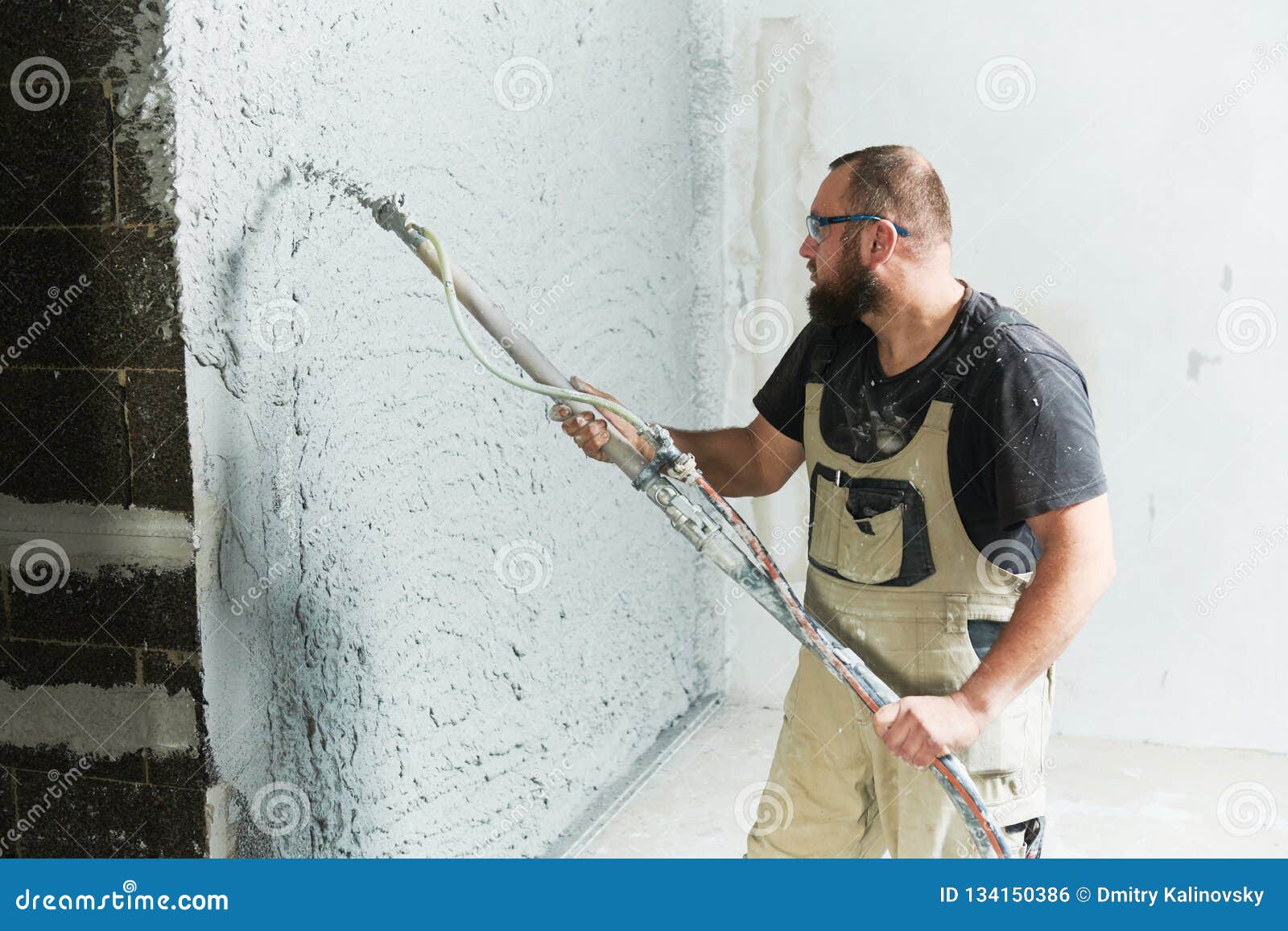Plasterer Using Screeder Spraying Putty Plaster Mortar on Wall Stock ...