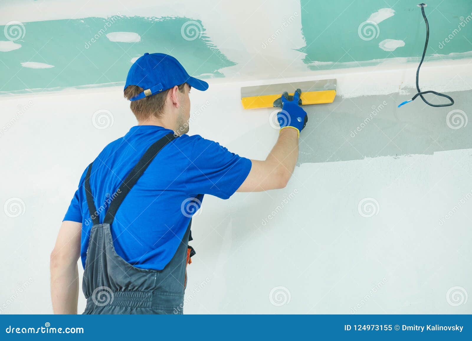 Refurbishment. Plasterer Worker Spackling a Wall with Putty Stock Image ...