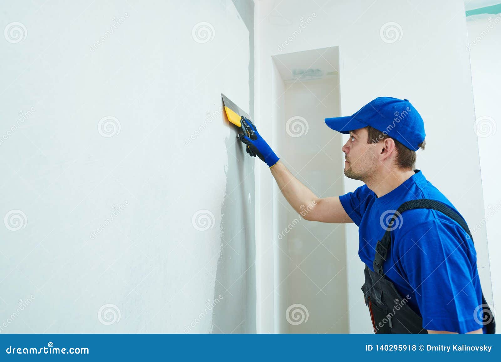 Refurbishment. Plasterer Worker Spackling a Wall with Putty Stock Photo ...