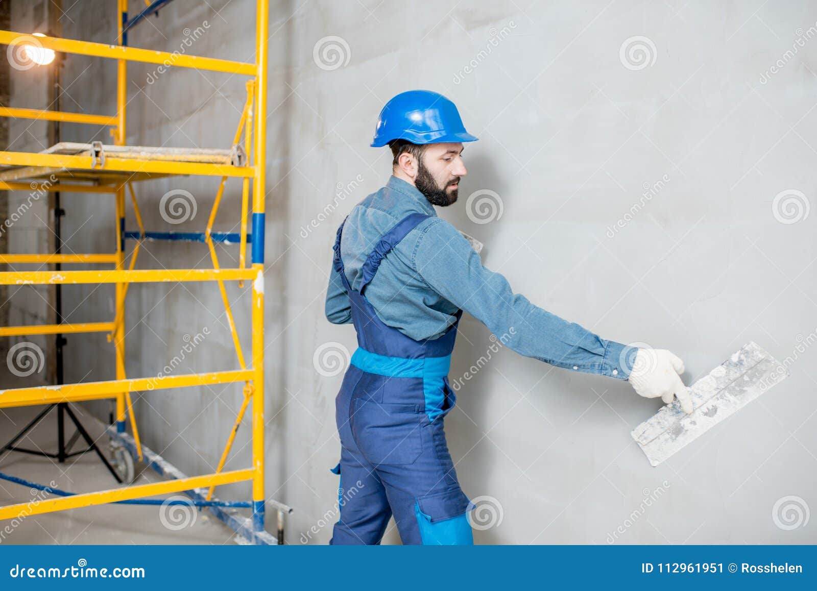 Plasterer working indoors stock image. Image of manual - 112961951
