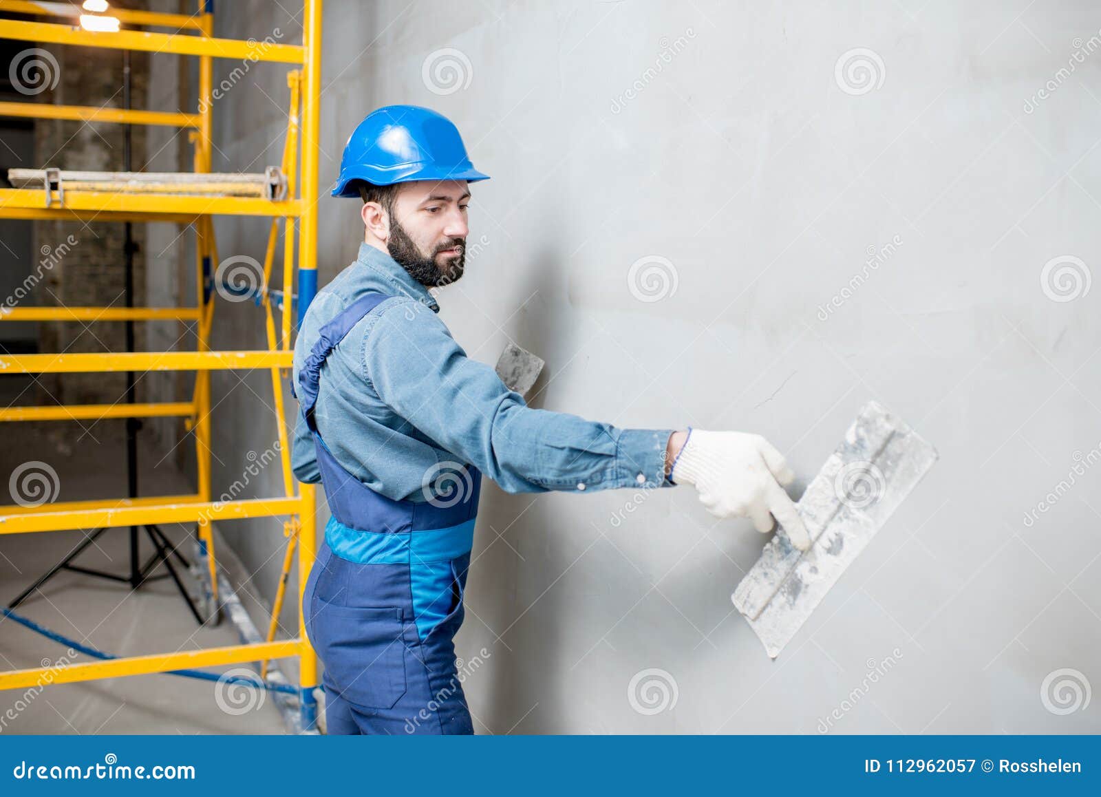 Plasterer working indoors stock image. Image of spatula - 112962057
