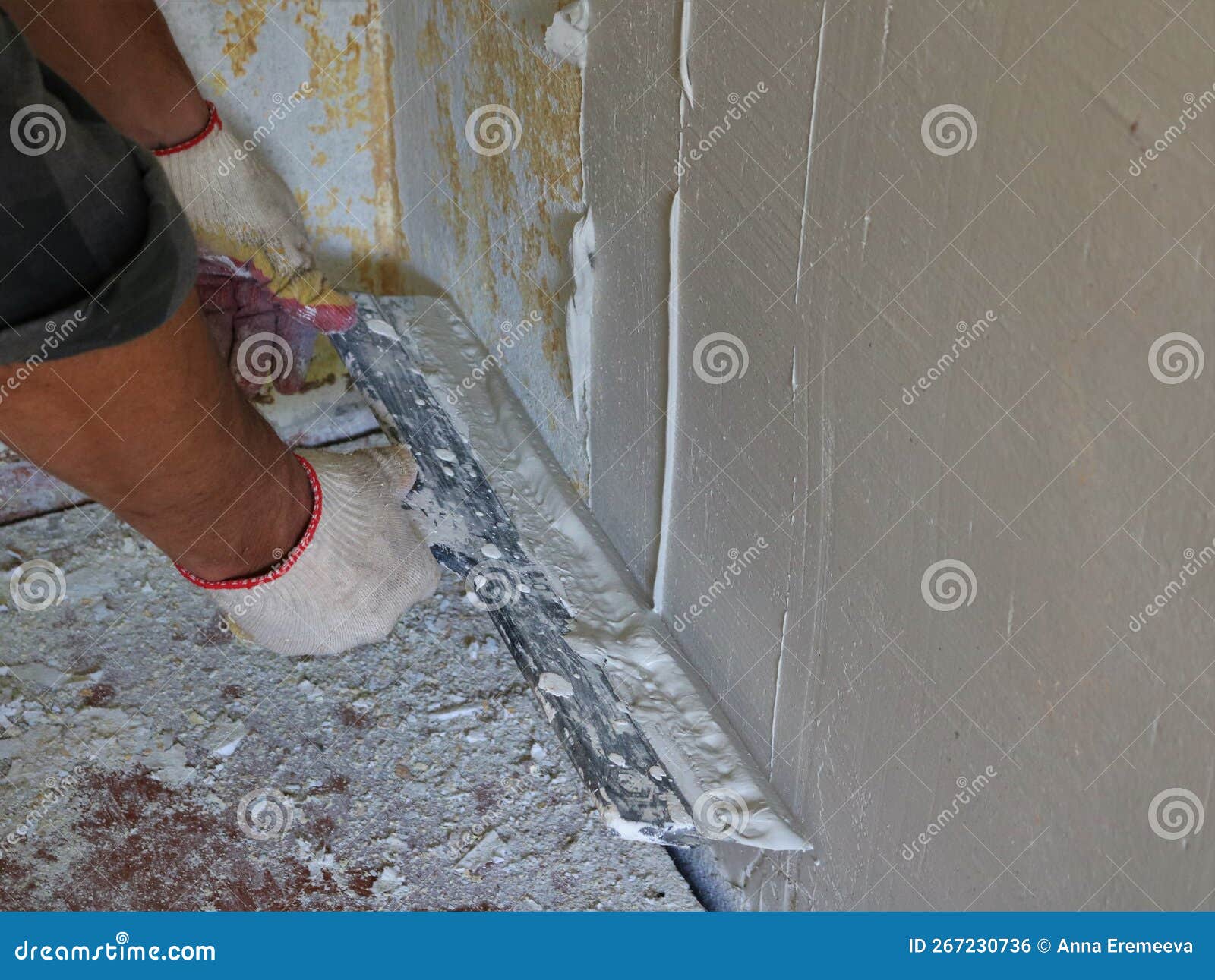Plastering the Wall with a Wide Trowel and Elastic Putty Stock Photo ...