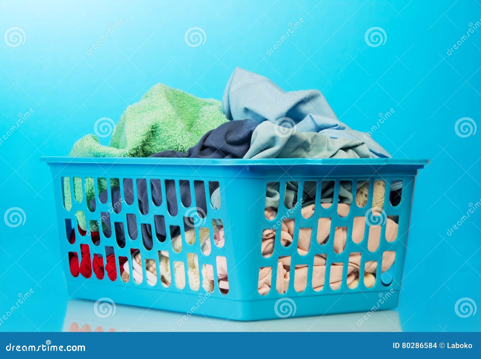 Plastic Basket with Clothes Washing on Blue Background. Stock Photo ...
