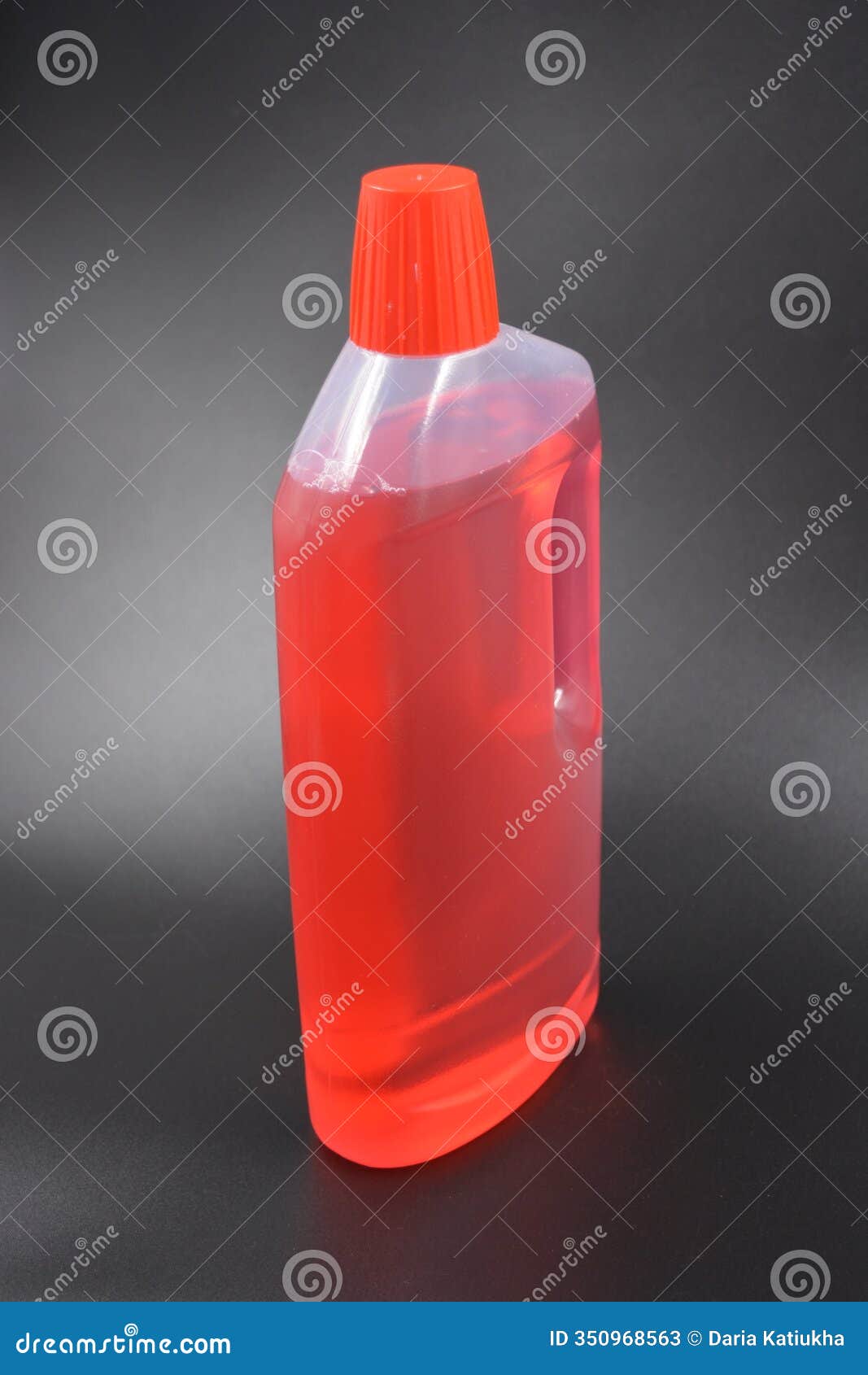 A Plastic Bottle Filled with a Red Liquid with a Bright Red Cap is ...
