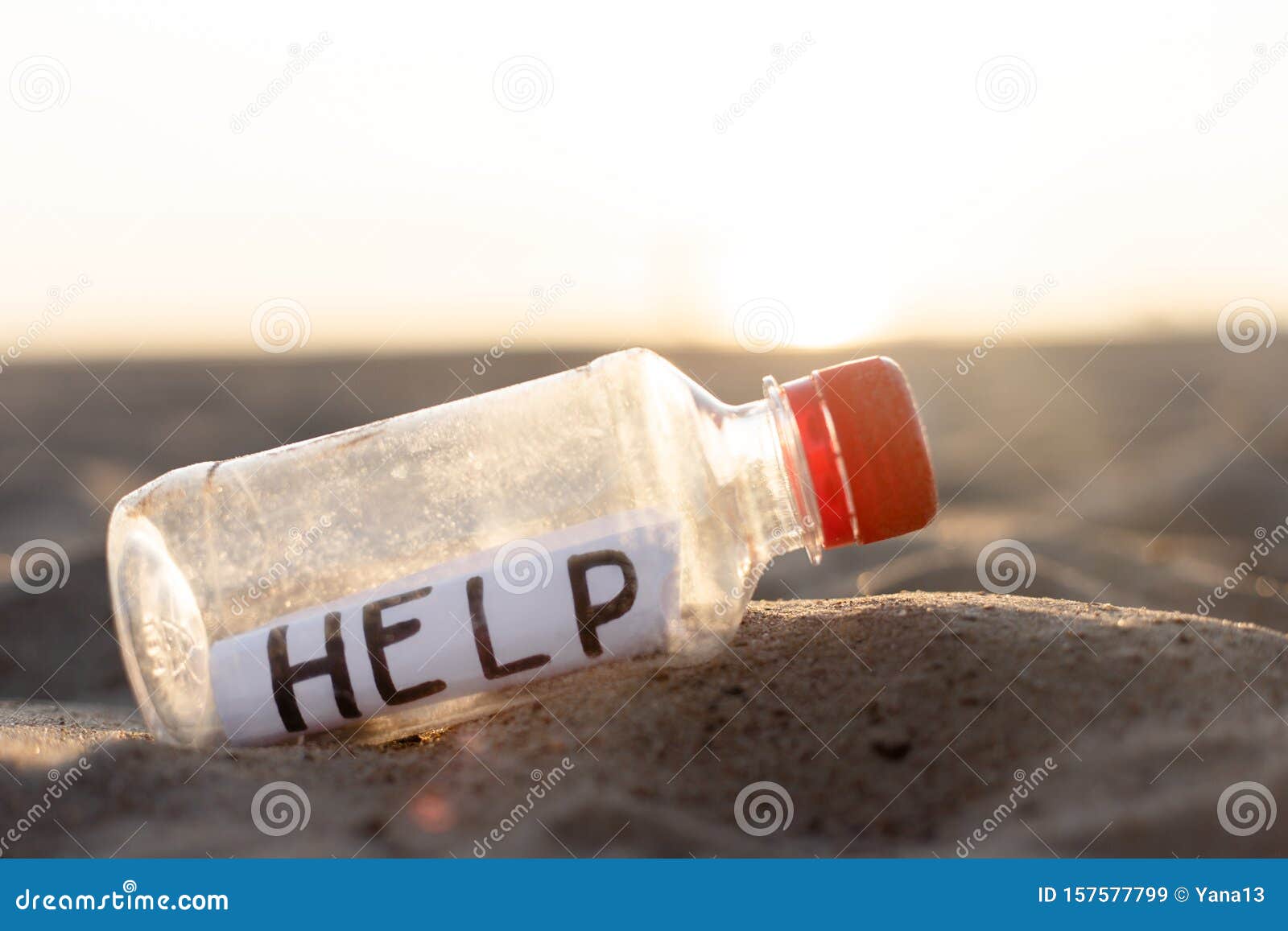 A Plastic Bottle with the Message Help Inside Lies on the Sand of a ...