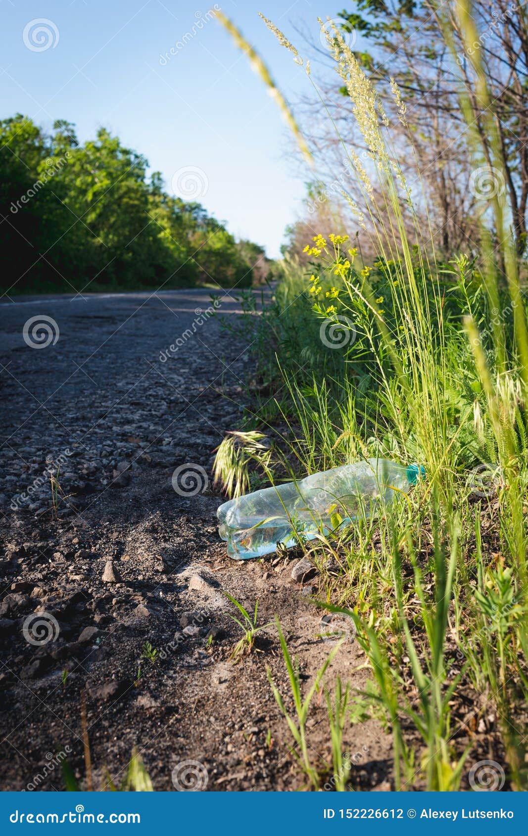 Plastic Bottle with Water by the Road Stock Photo - Image of road ...
