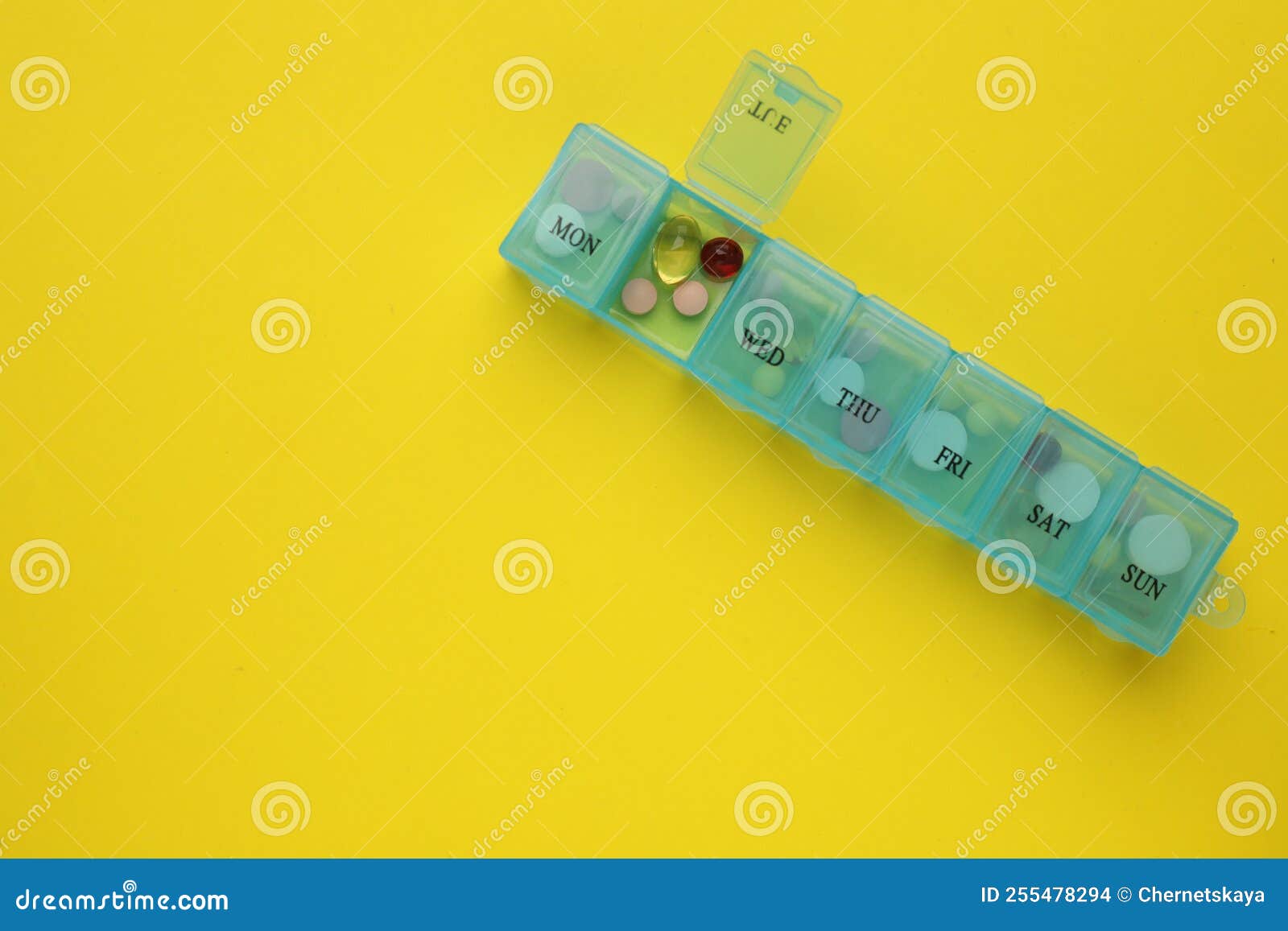 Plastic Box with Different Pills on Yellow Background, Top View. Space ...
