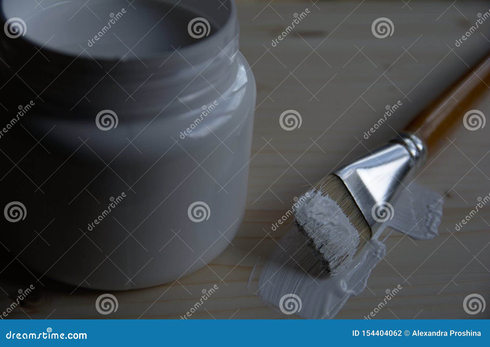 Plastic Can with White Acrylic Primer and a Bristle Brush on a Wooden ...