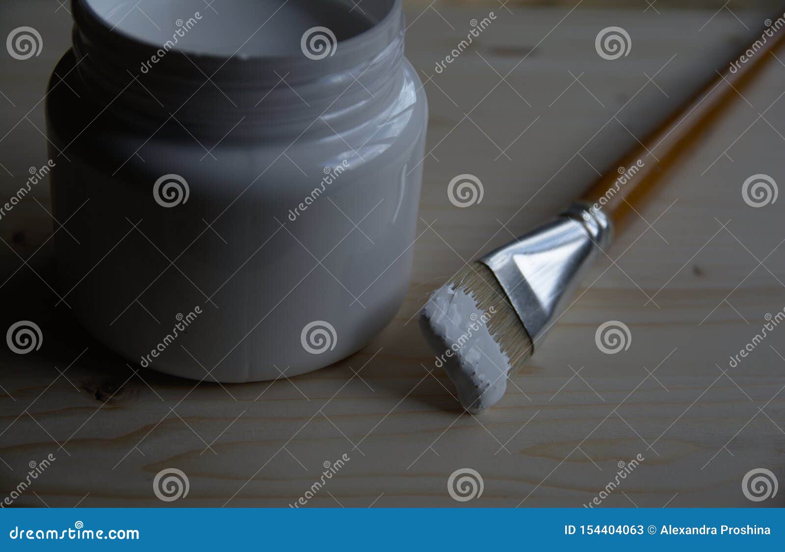 Plastic Can with White Acrylic Primer and a Bristle Brush on a Wooden ...