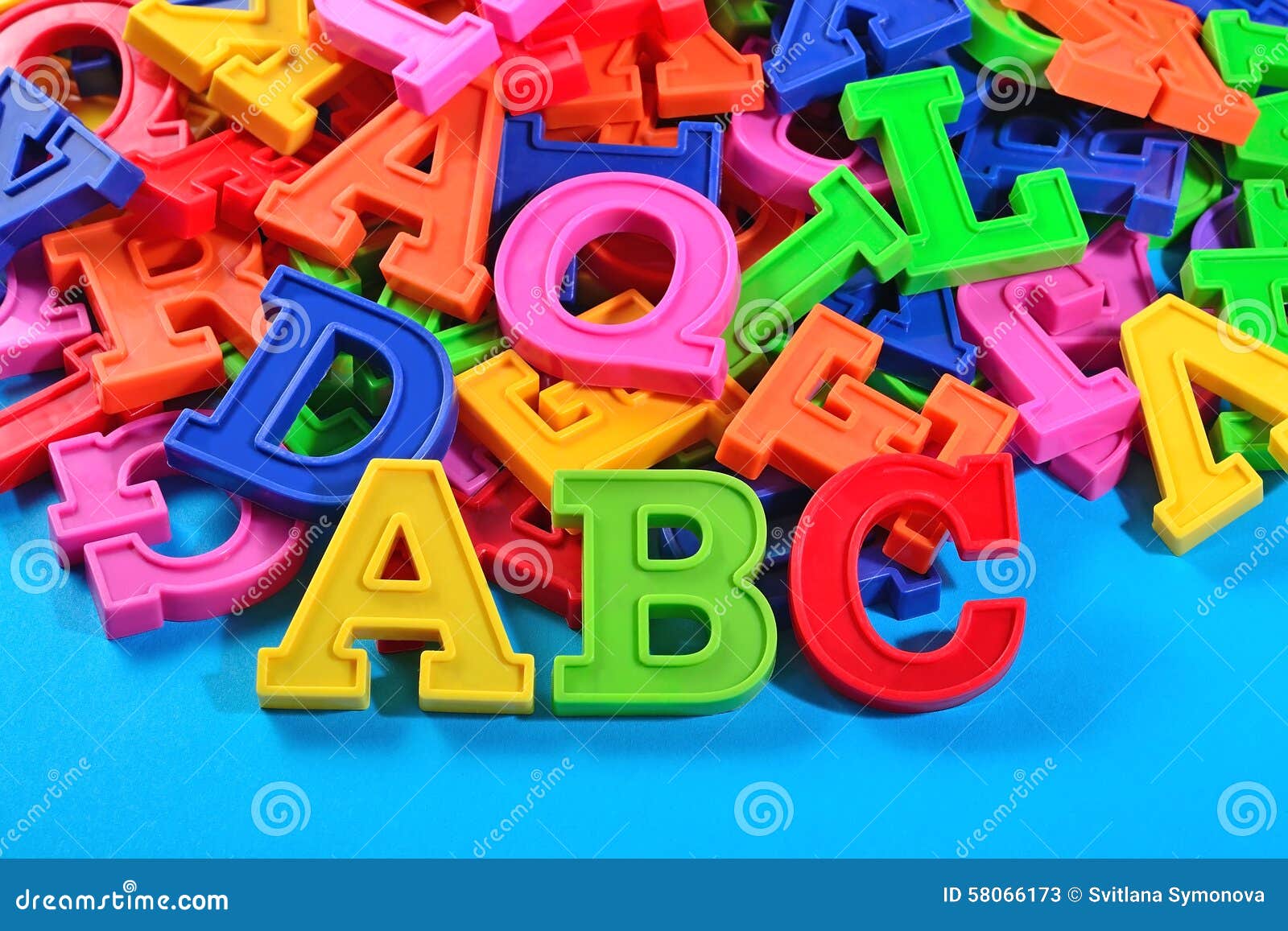 Plastic Colored Alphabet Letters ABC on a Blue Stock Image - Image of ...