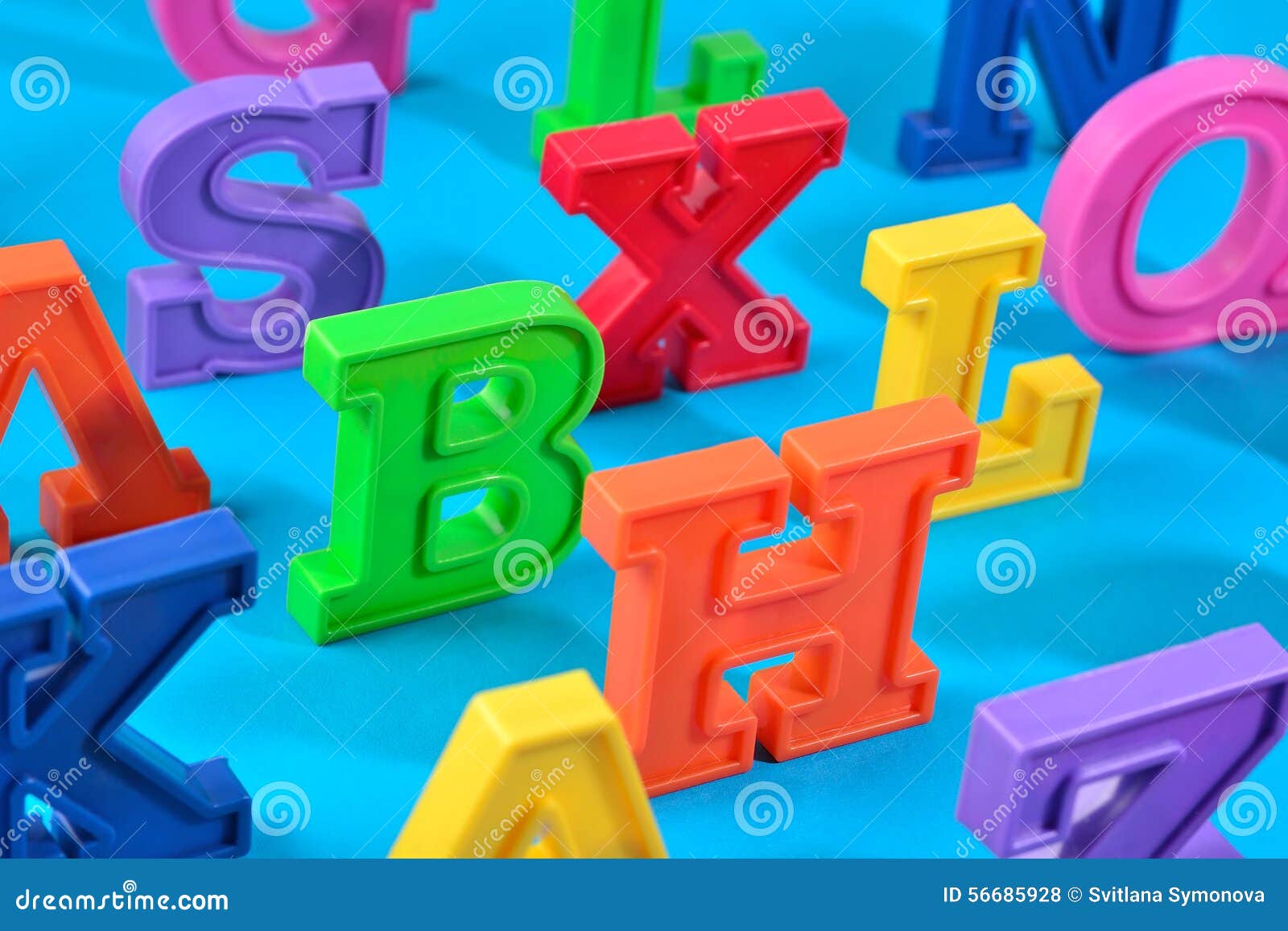 Plastic Colorful Alphabet Letters Close Up on a Blue Stock Photo ...