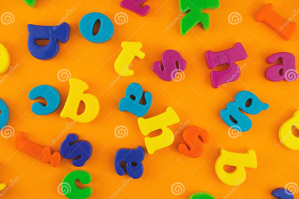 Plastic Colourful Alphabet Letters on the Orange Background Stock Image ...