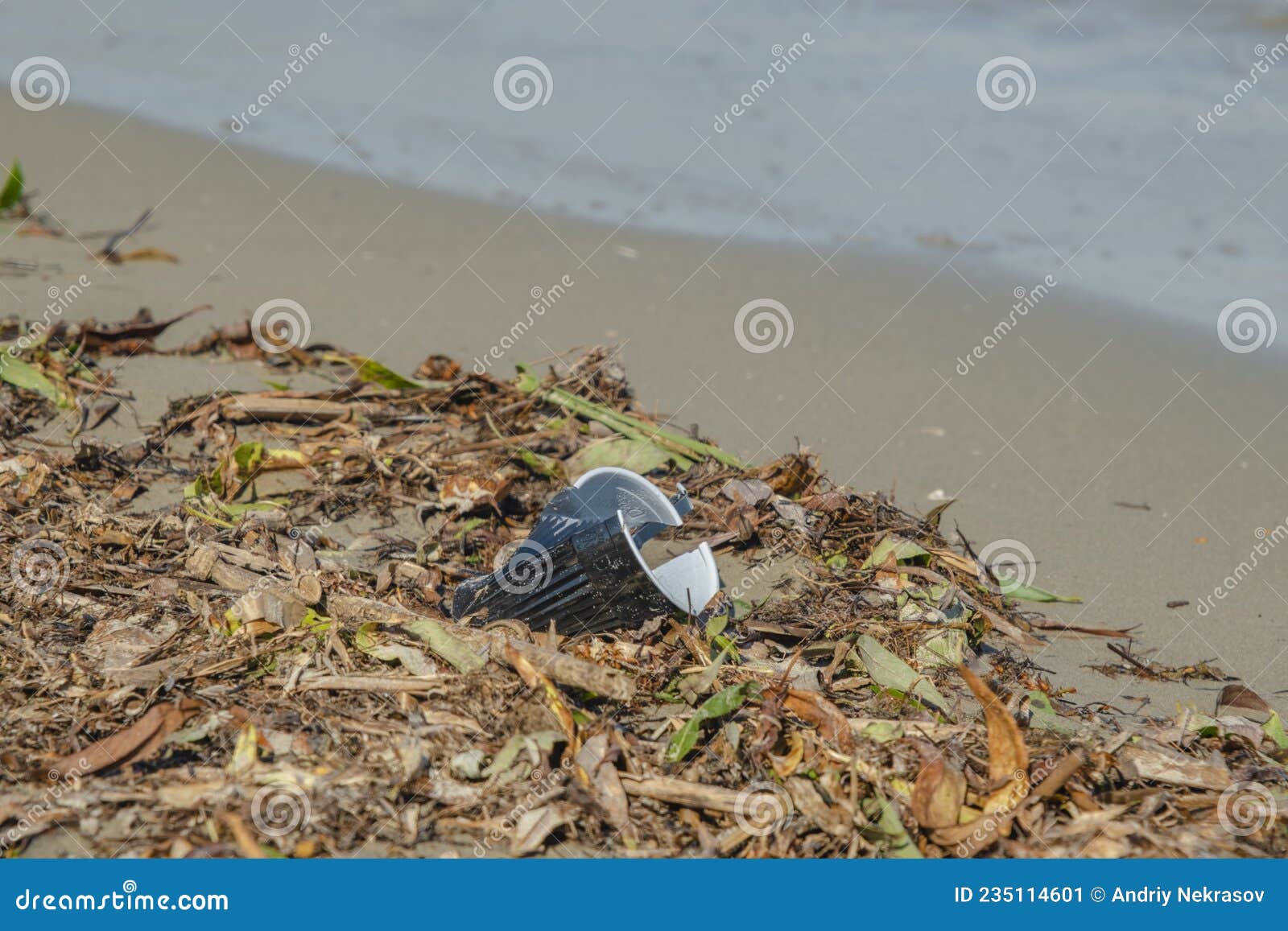 A Plastic Cup Washed Ashore by the Waves. Massive Plastic Pollution on ...