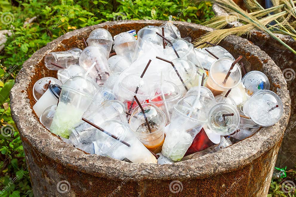 Plastic cups in trashcan. stock photo. Image of glass - 68535114