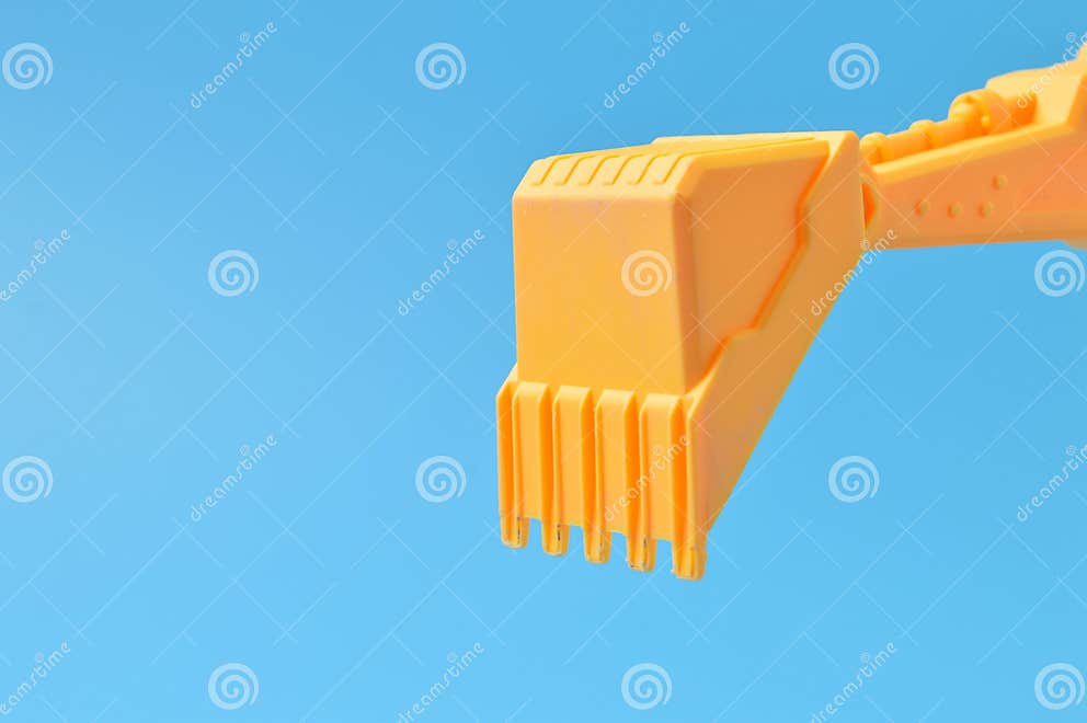 Plastic Digger Toy Isolated on a Blue Background Stock Image - Image of ...