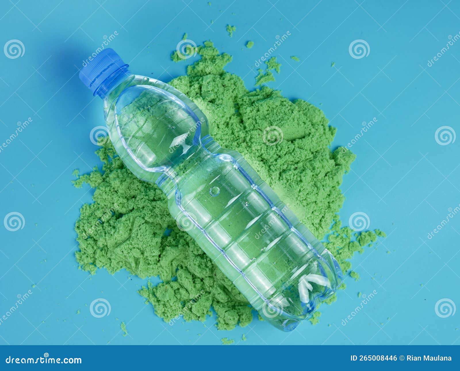 Plastic Drink Bottle on Green Sand Isolated on Blue Background Stock ...