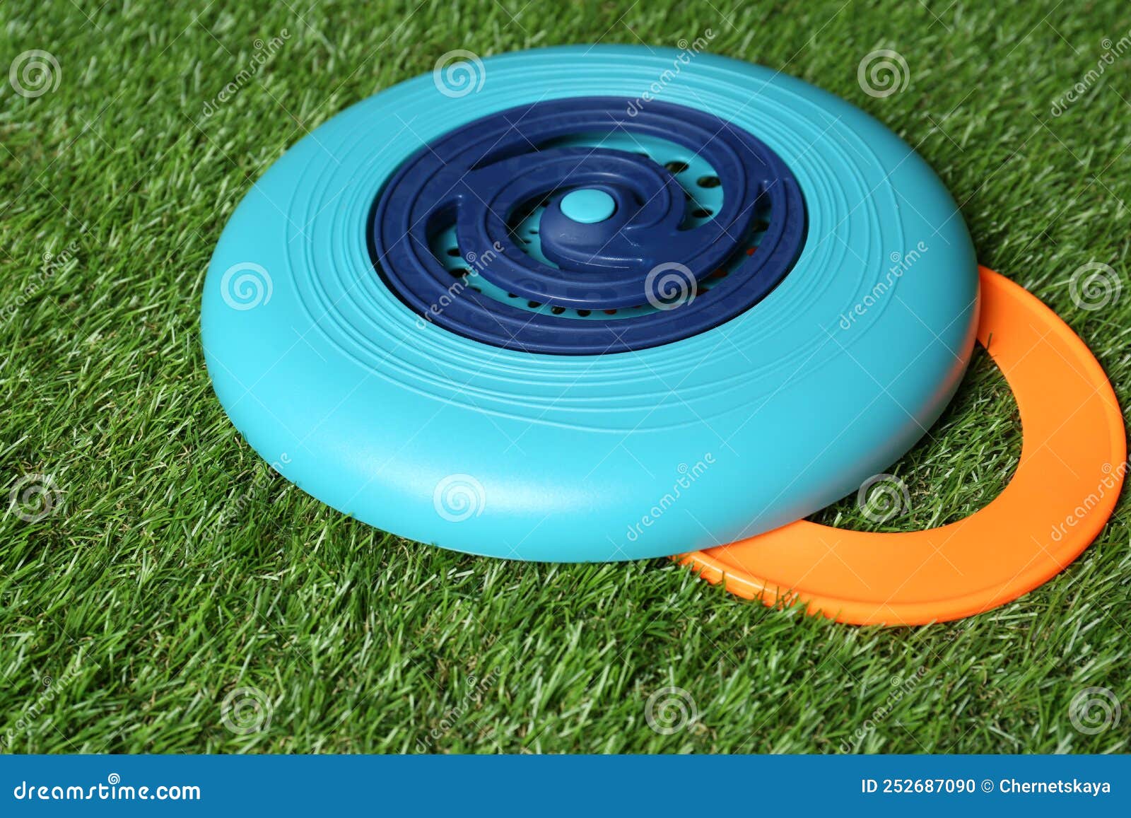 Plastic Frisbee Disk and Ring on Green Grass, Closeup Stock Photo ...