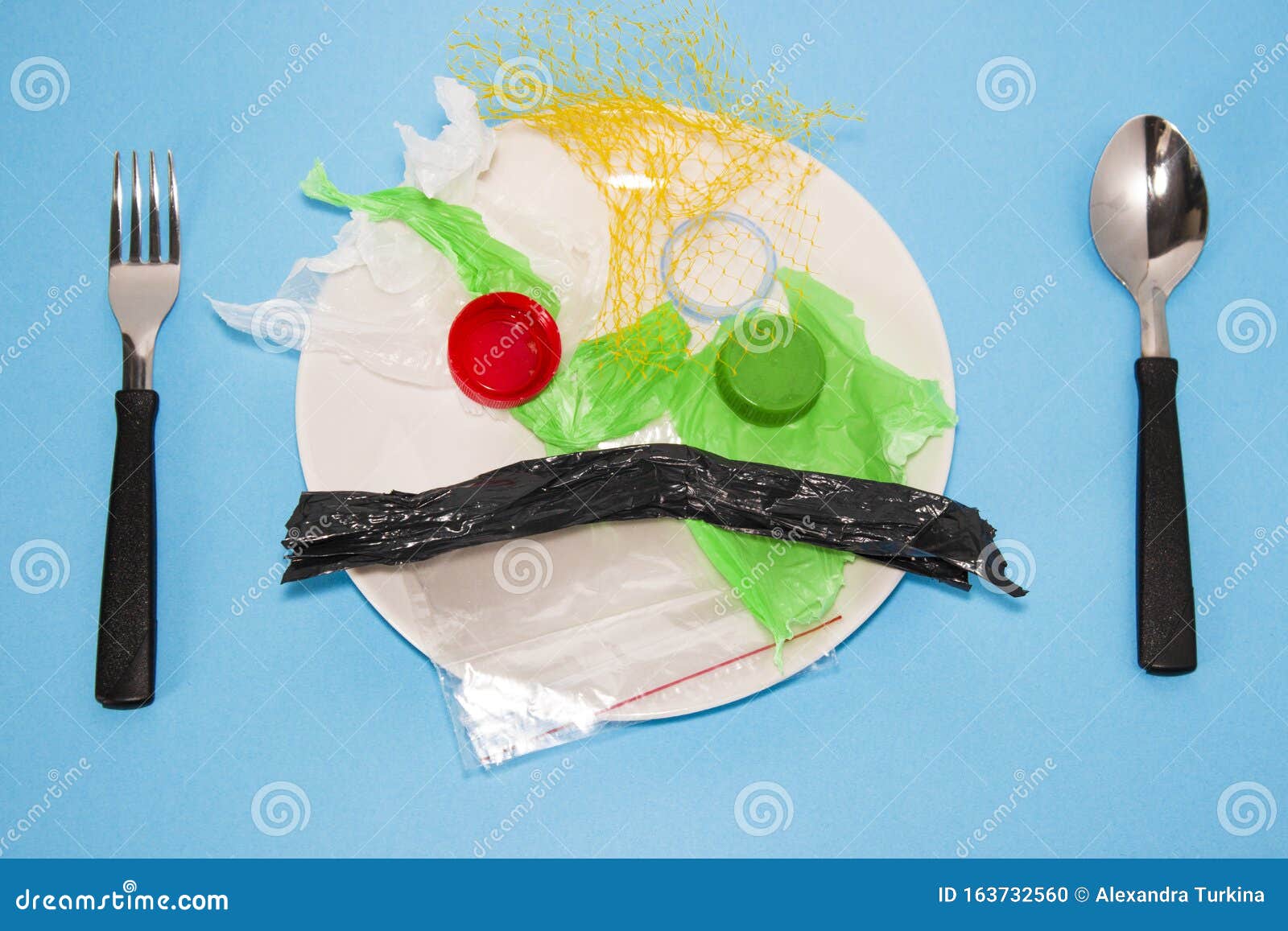 Plastic Garbage On A Plate, Next To A Fork And Spoon. Environment ...