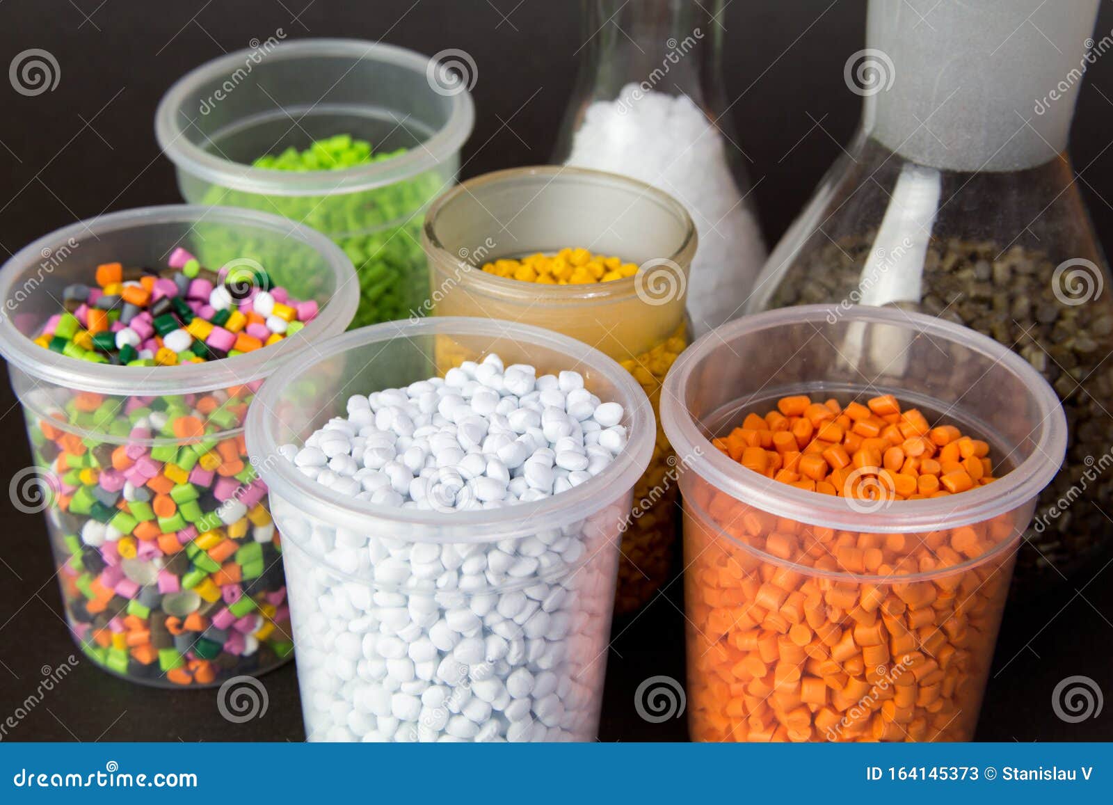 Plastic Granules in a Measuring Container and Test Tubes in the ...