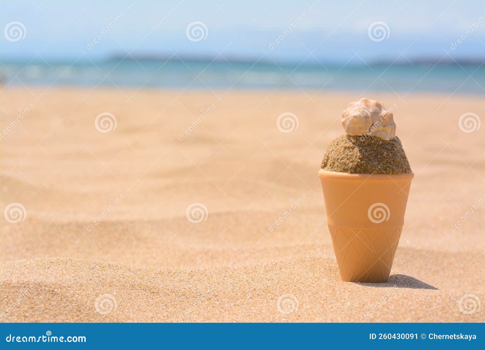 Plastic Ice Cream Shaped Mold with Ball of Sand and Seashell on Beach ...