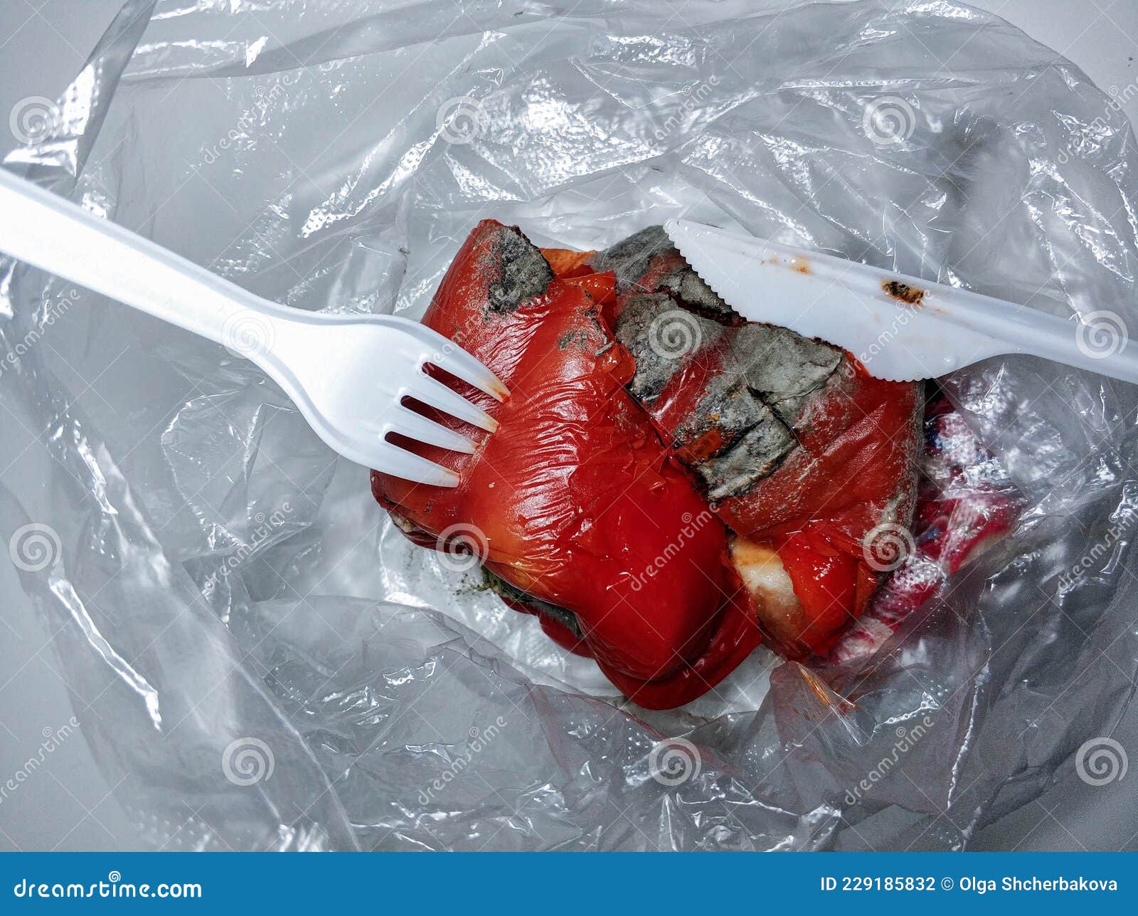A Plastic Knife and Fork are Stuck in the Spoiled Red Pepper in the Bag ...