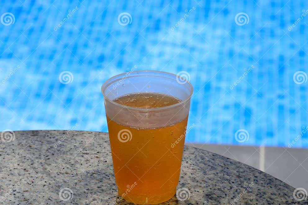 Plastic Lager Cup by the Pool Stock Photo - Image of cool, refreshment ...