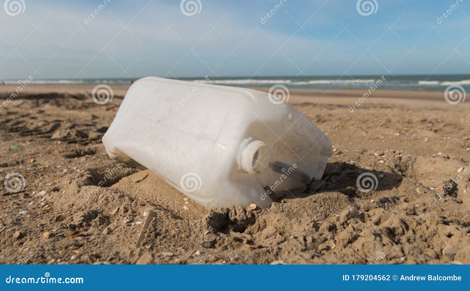 Plastic Liquid Container Discarded on a Sandy Beach Stock Photo - Image ...