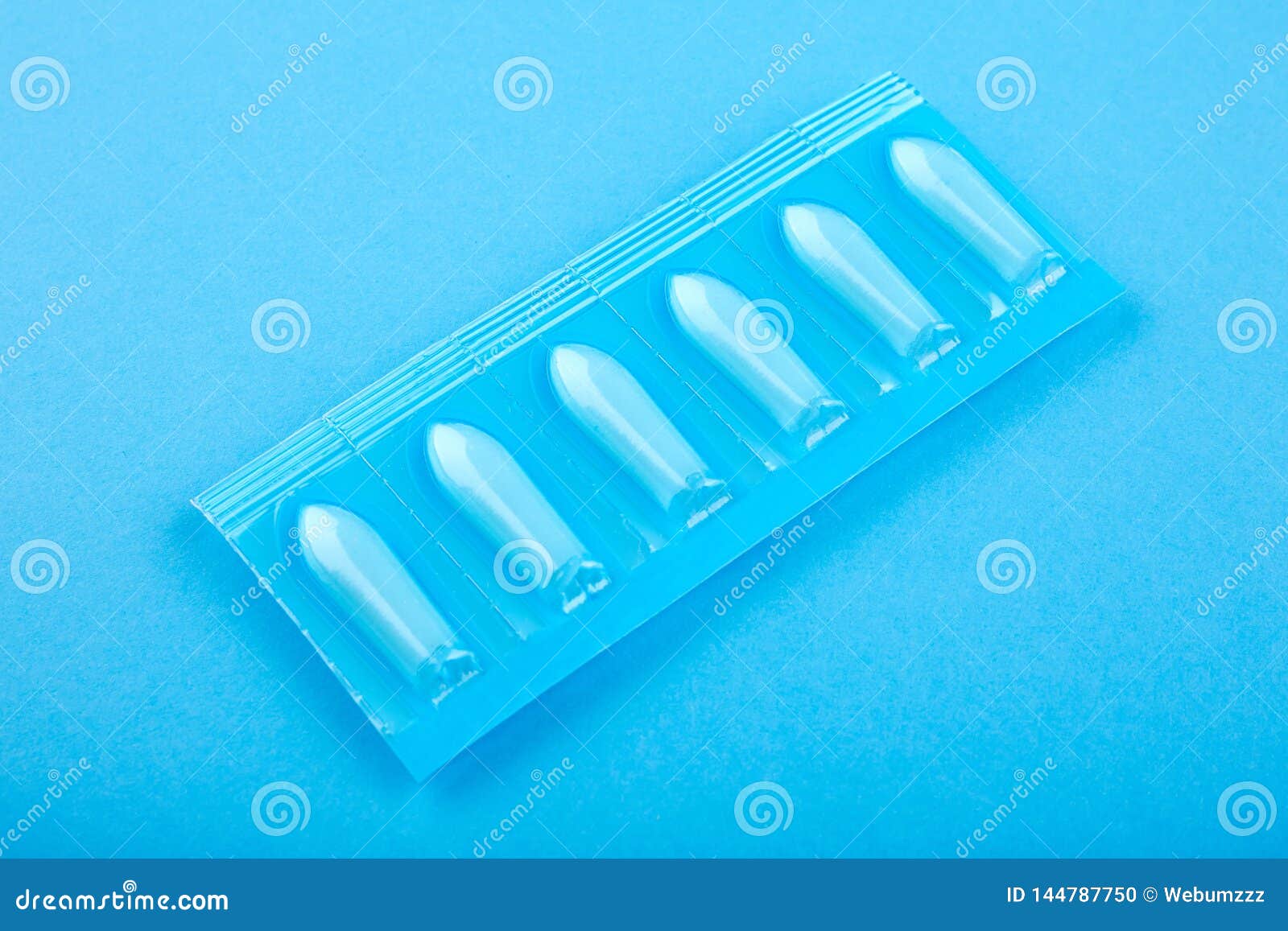 Plastic Package with Suppository on Blue Background Stock Photo - Image ...