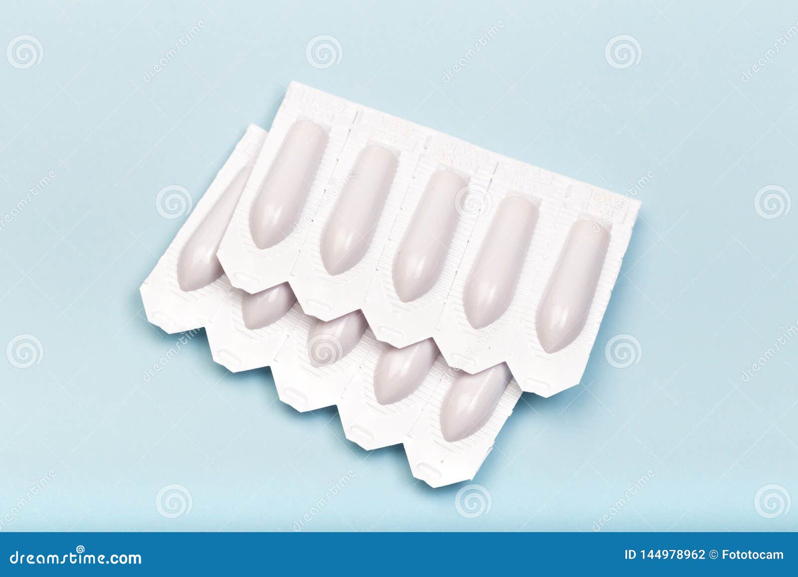 Plastic Packs of Suppositories on Blue Background Stock Photo - Image ...