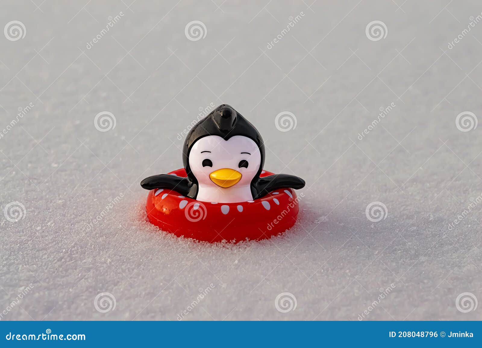 Plastic Penguin Toy with Red Rubber Ring in Snow Stock Photo - Image of ...