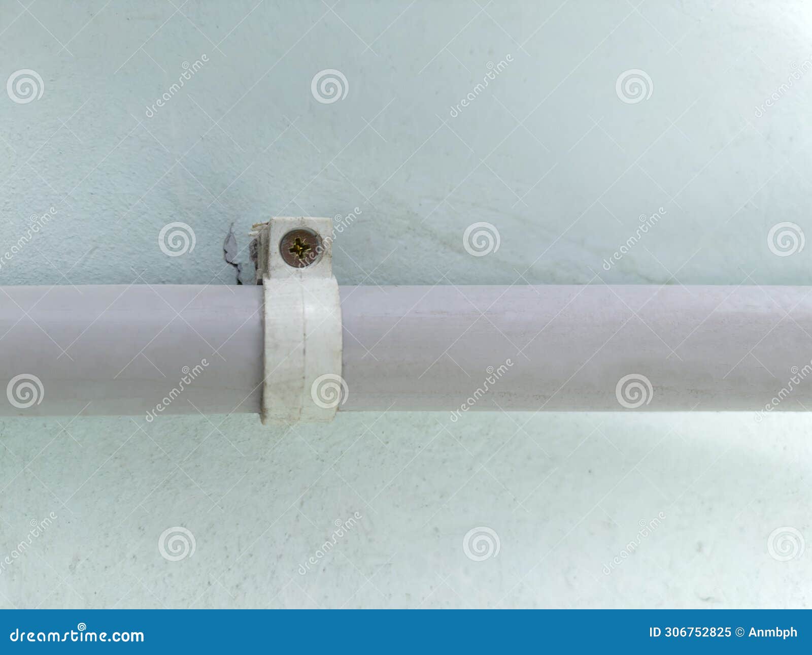 Plastic Pipe Fixed To the Wall with Plastic Pipe Clamp Stock Image ...
