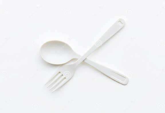 Plastic Spoon and Plastic Fork in a Crossed Position, Isolated on a ...