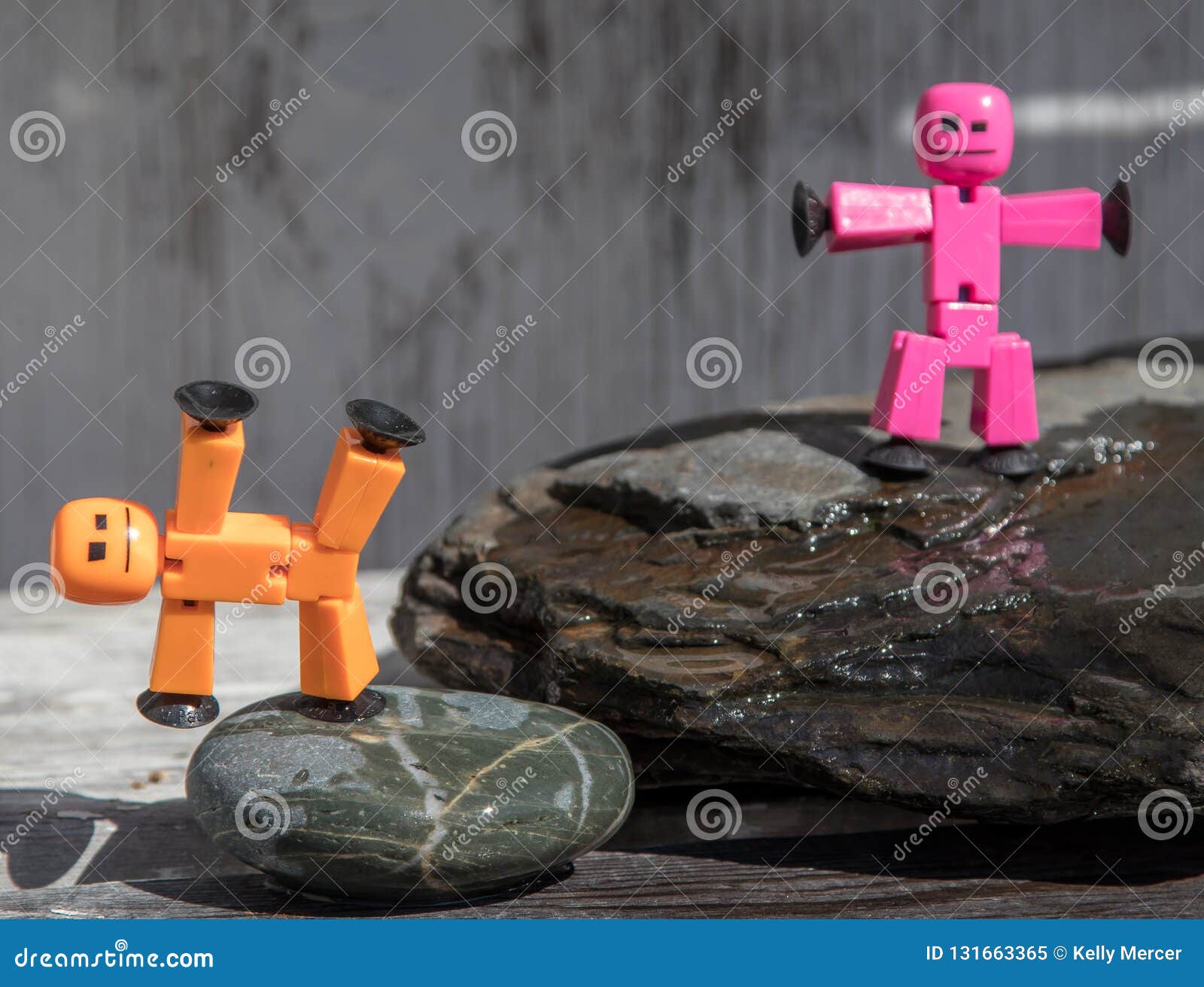 Plastic Stick Figure Posed On Wet Rock By Lighthouse. Royalty-Free ...