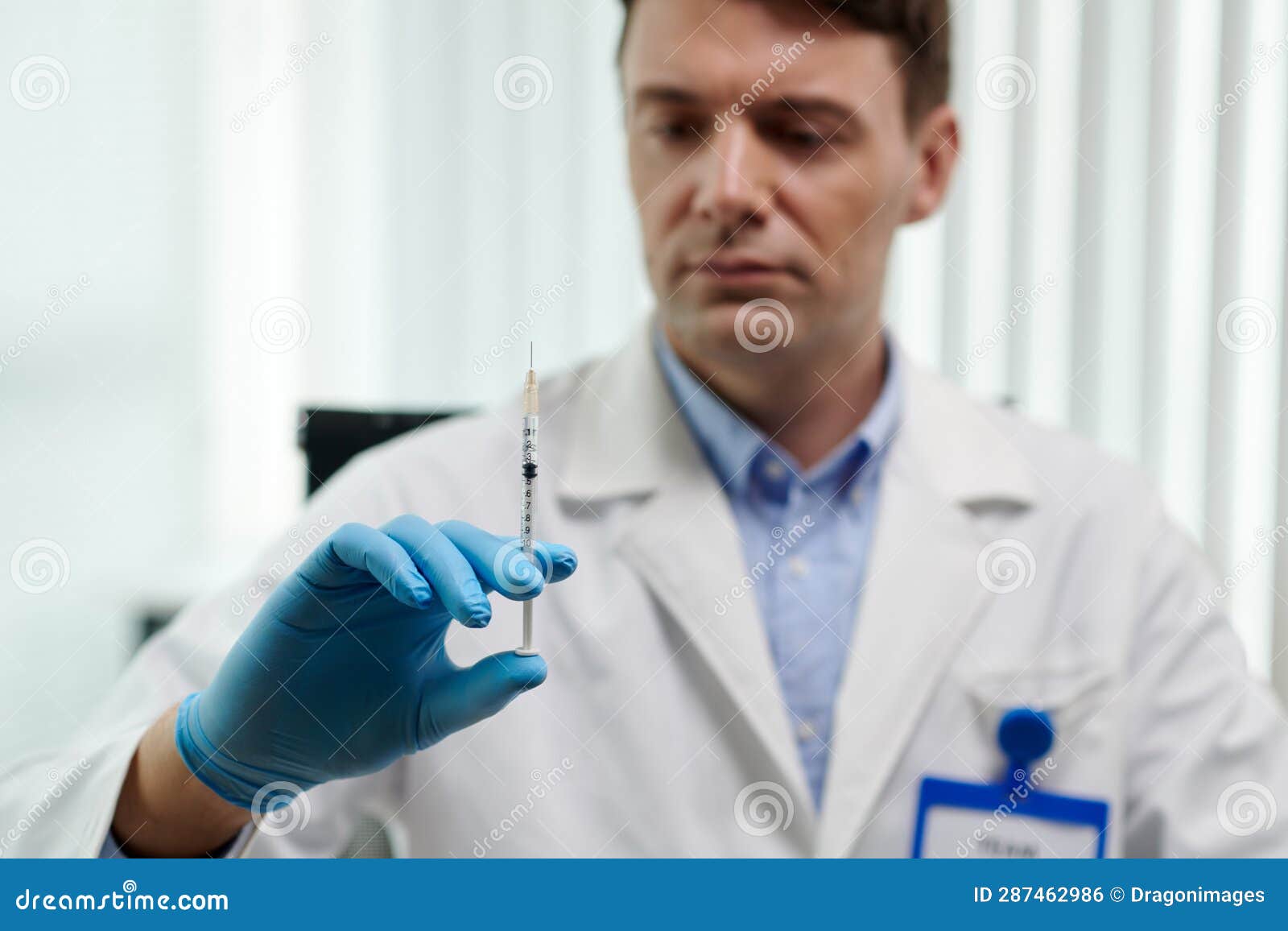 Plastic Surgeon Looking at Syringe Stock Photo - Image of surgeon ...