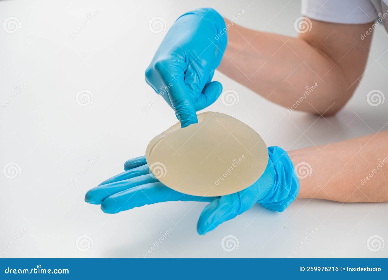 A Plastic Surgeon Shows a Breast Silicone Implant. Stock Photo - Image ...