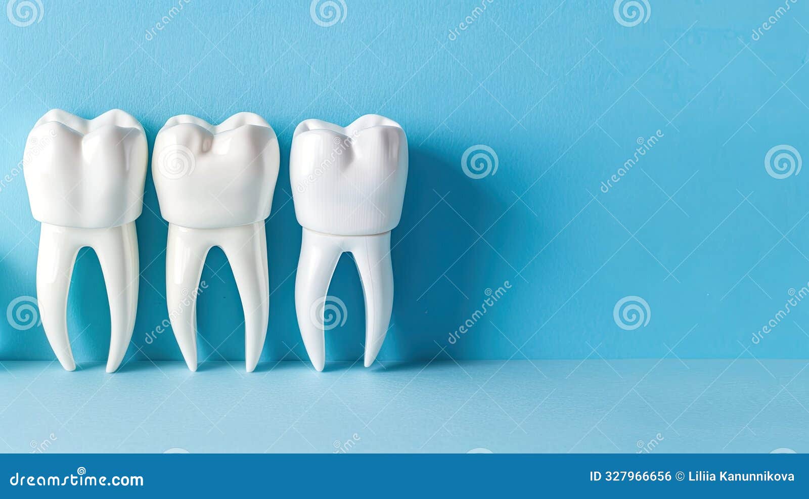 Plastic Teeth Stand Side by Side on a Blue Background, a Larger Molar ...