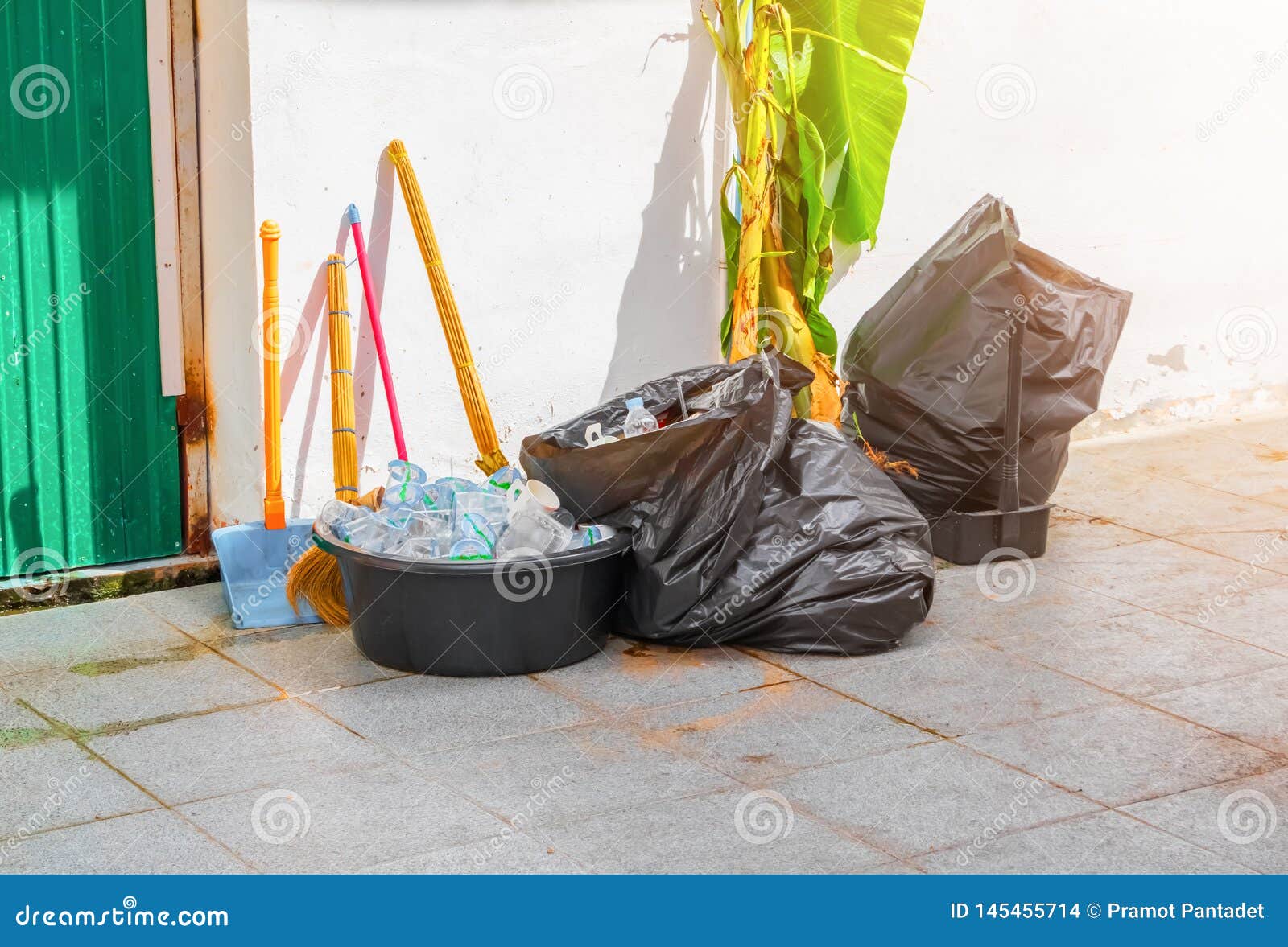 Plastic Trash Bag. Pile Black Garbage on Floor beside the Building Wall ...
