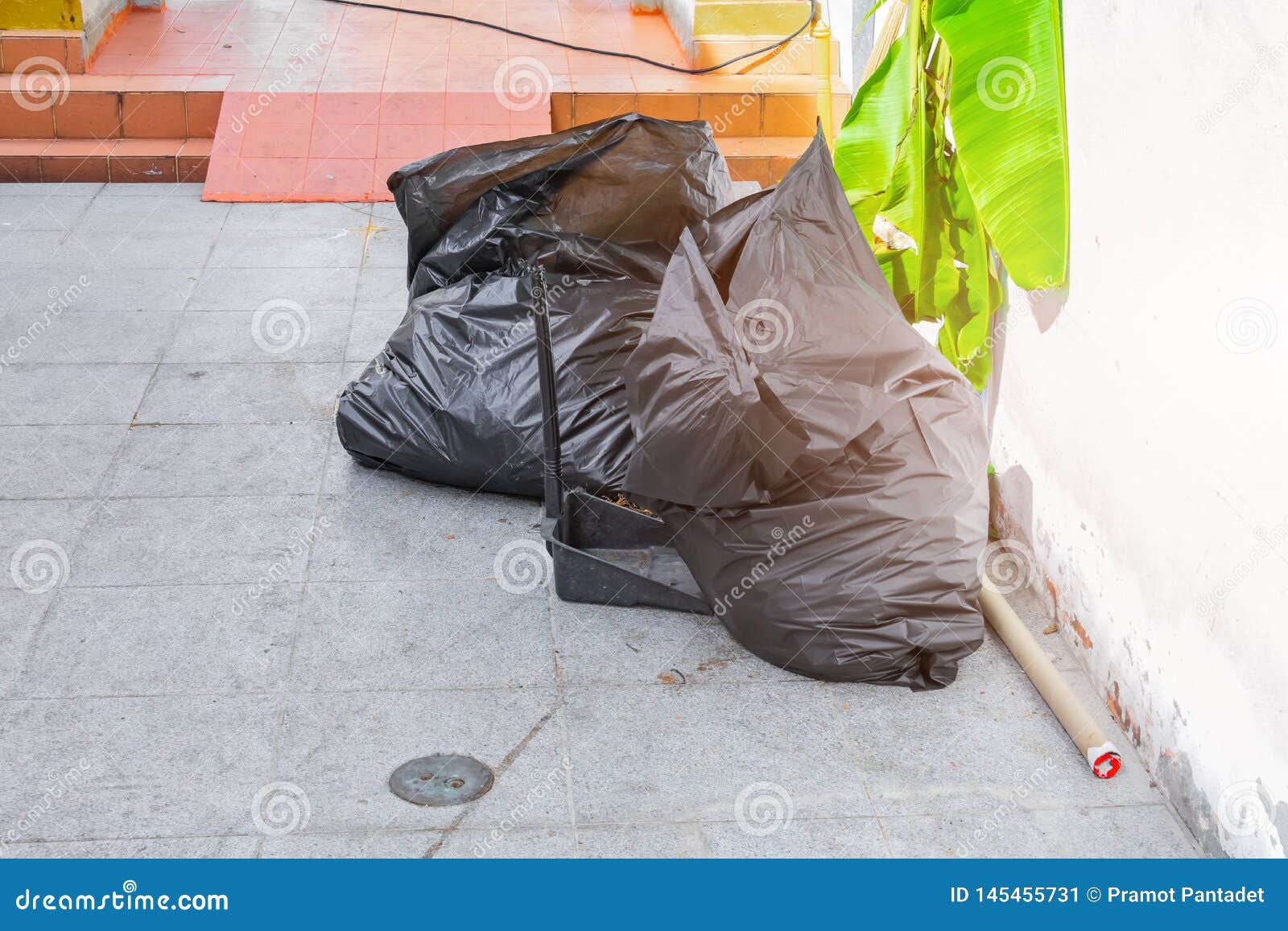 Plastic Trash Bag. Pile Black Garbage on Floor beside the Building Wall ...