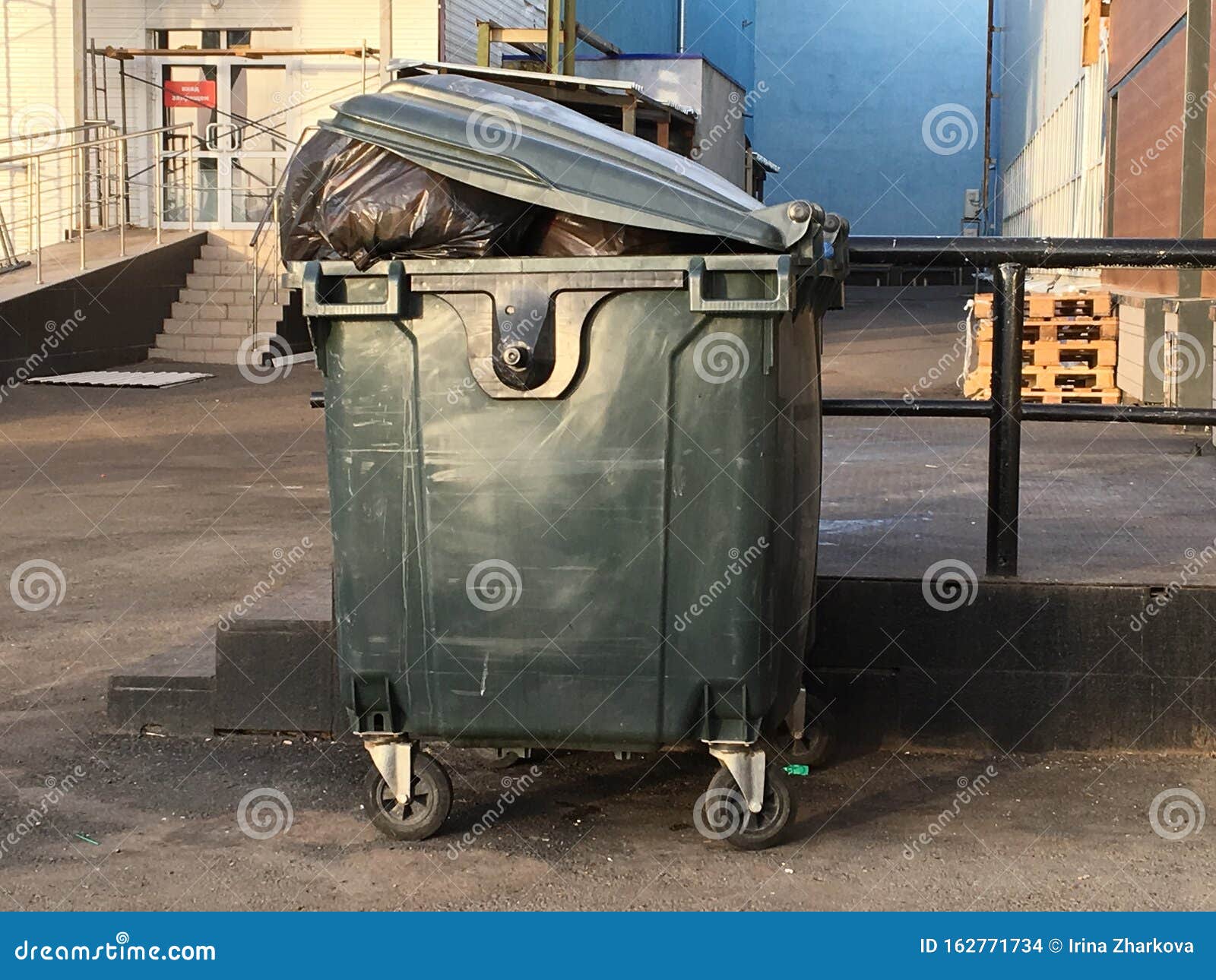 Plastic Trash Can with Waste on the Street. Garbage Can Stock Photo ...