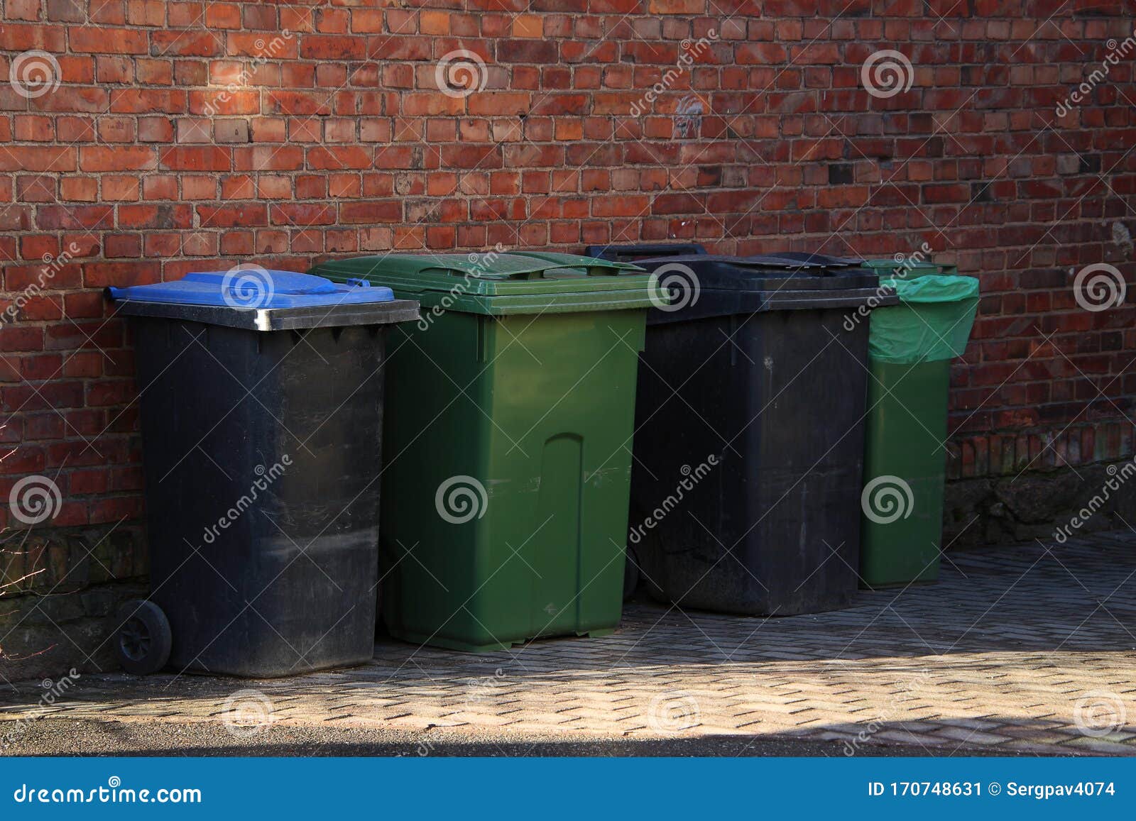Garbage Cans Against a Brick Wall Stock Image - Image of fence ...