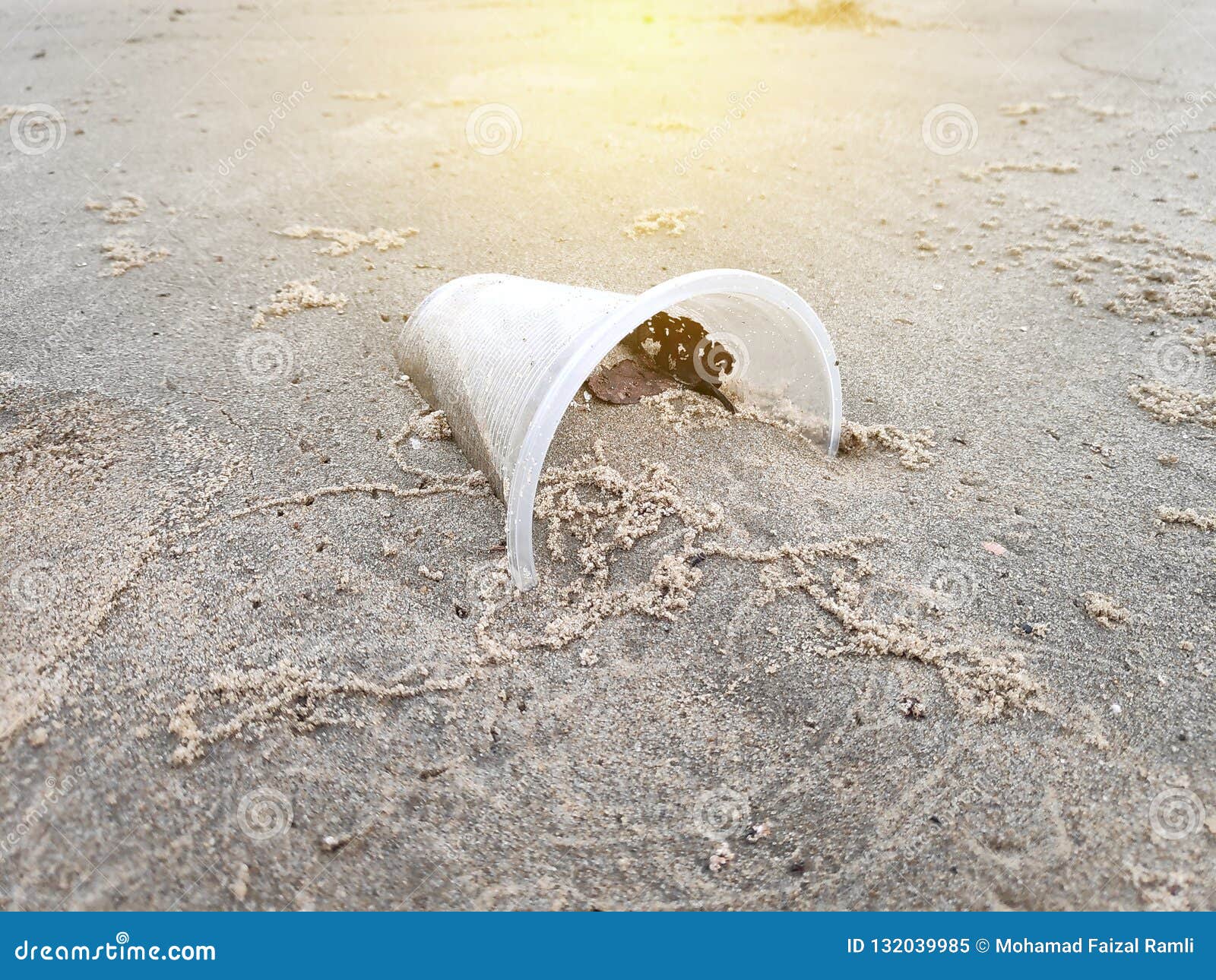 Plastic Trash or Garbage by the Beach with Sun Flare. Pollution and ...