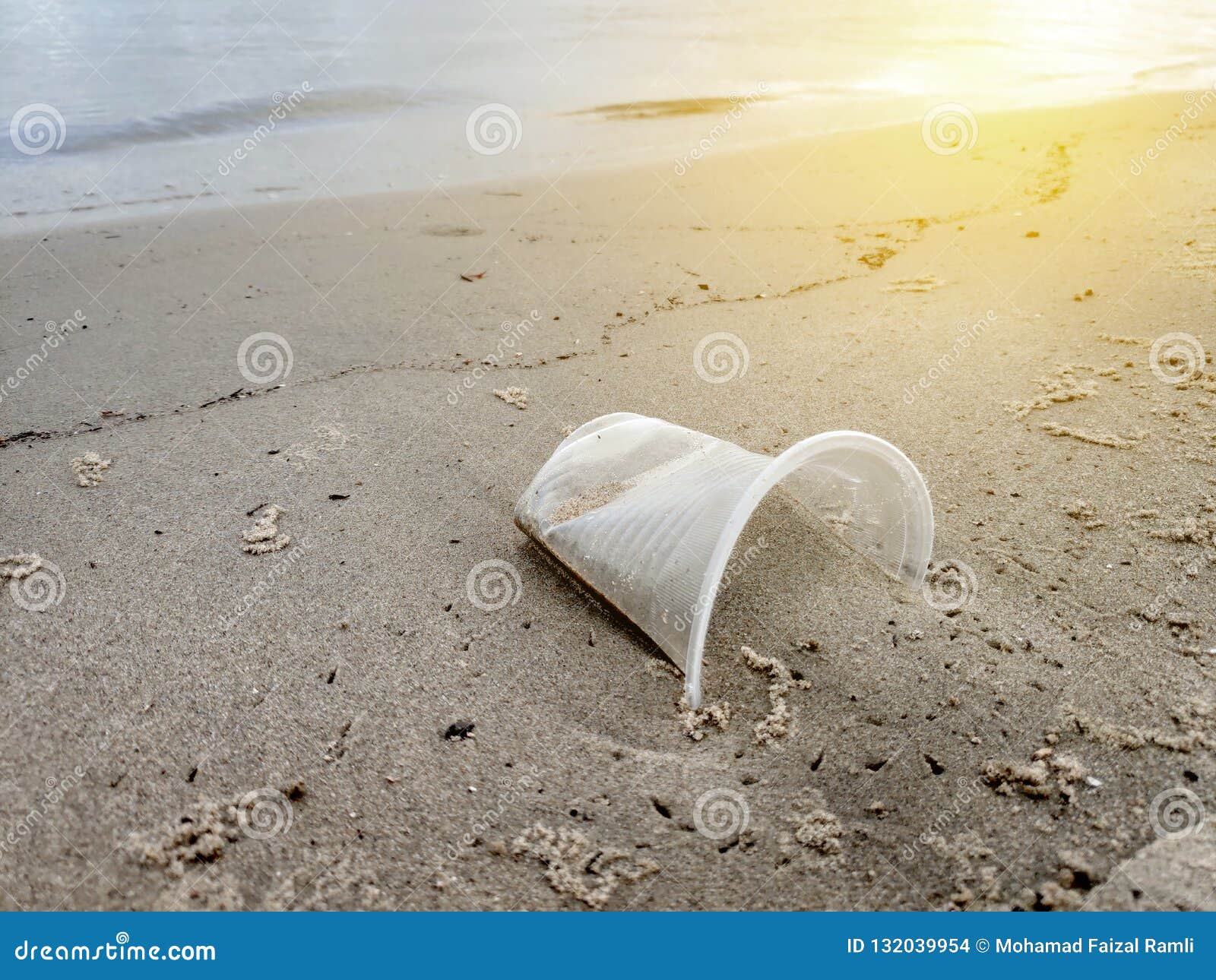 Plastic Trash or Garbage by the Beach with Sun Flare. Pollution and ...