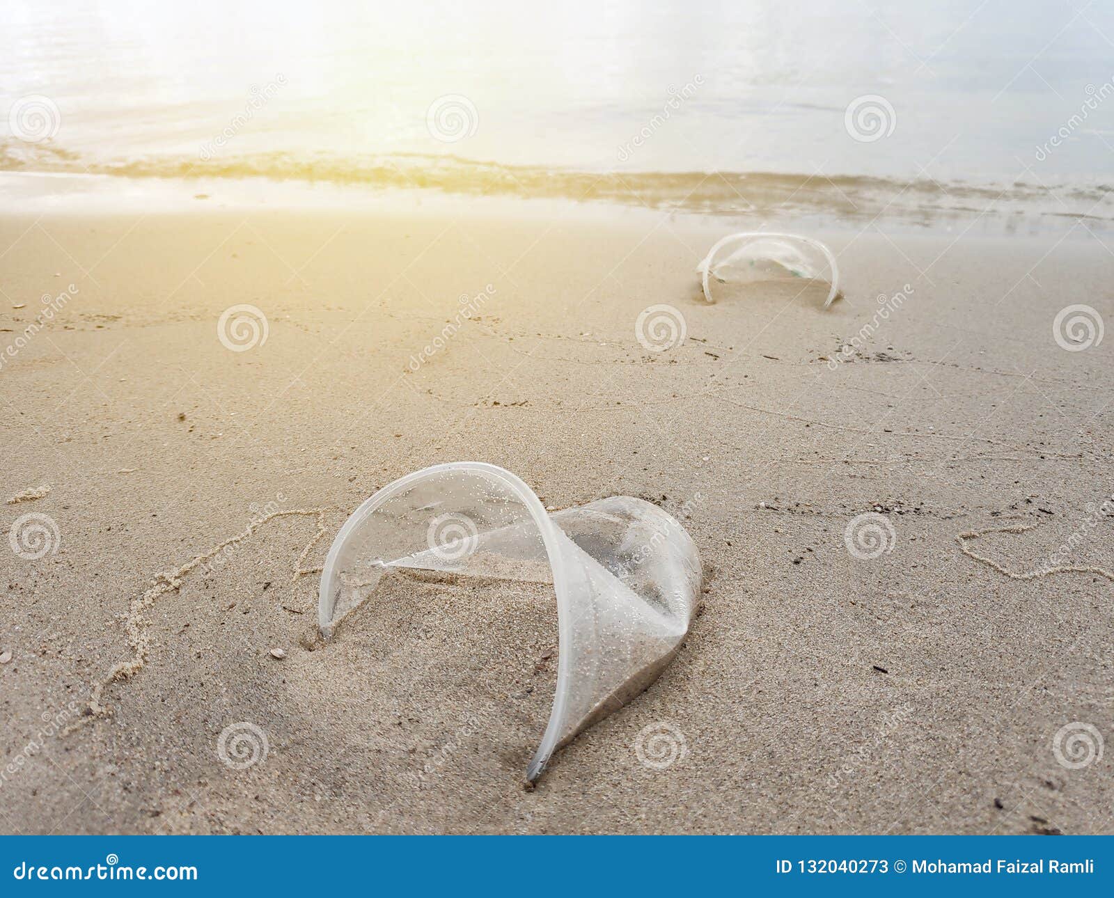 Plastic Trash or Garbage by the Beach with Sun Flare. Pollution and ...
