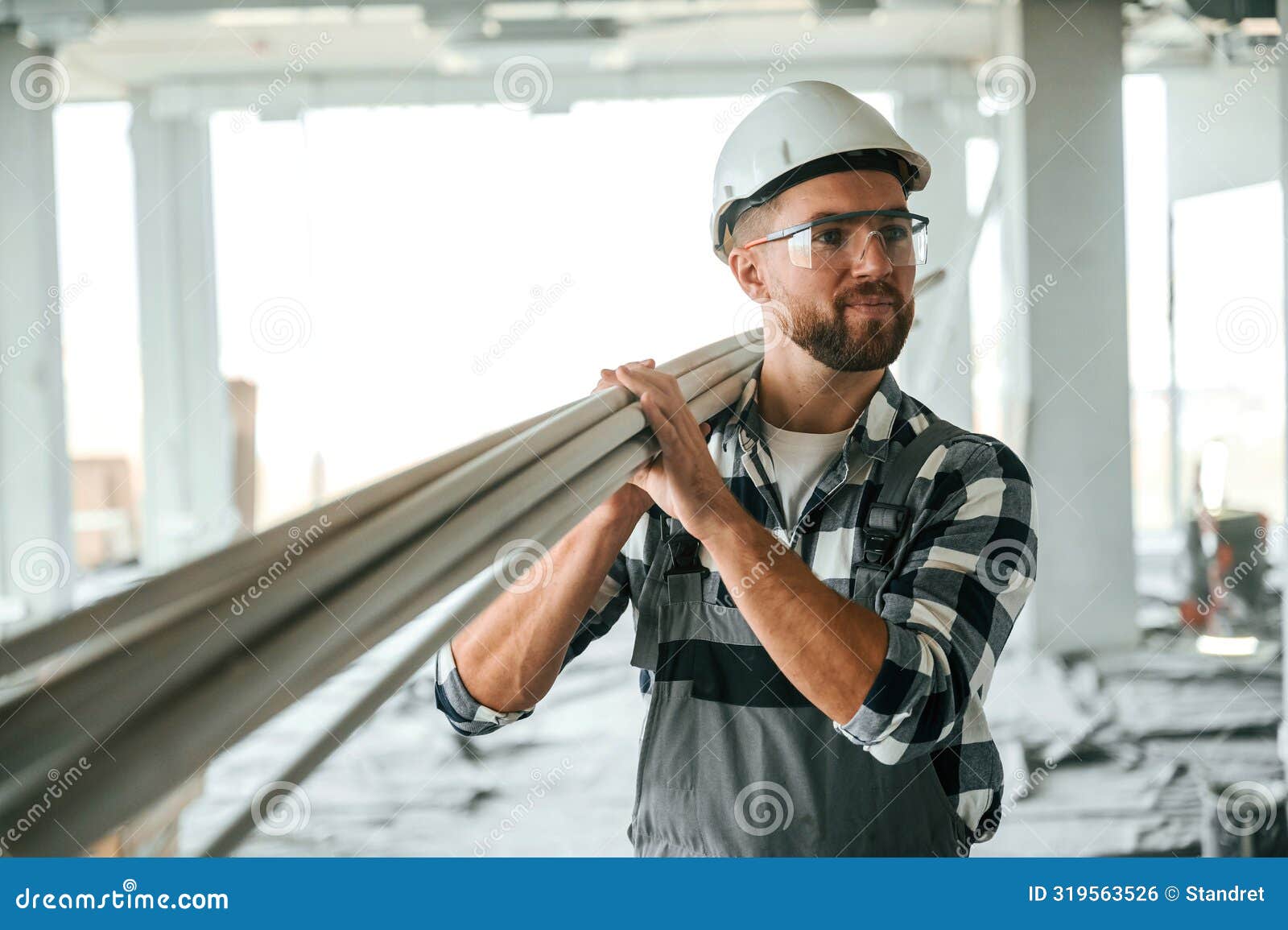 Plastic Tubes in Hands. Construction Worker in Uniform in Empty ...